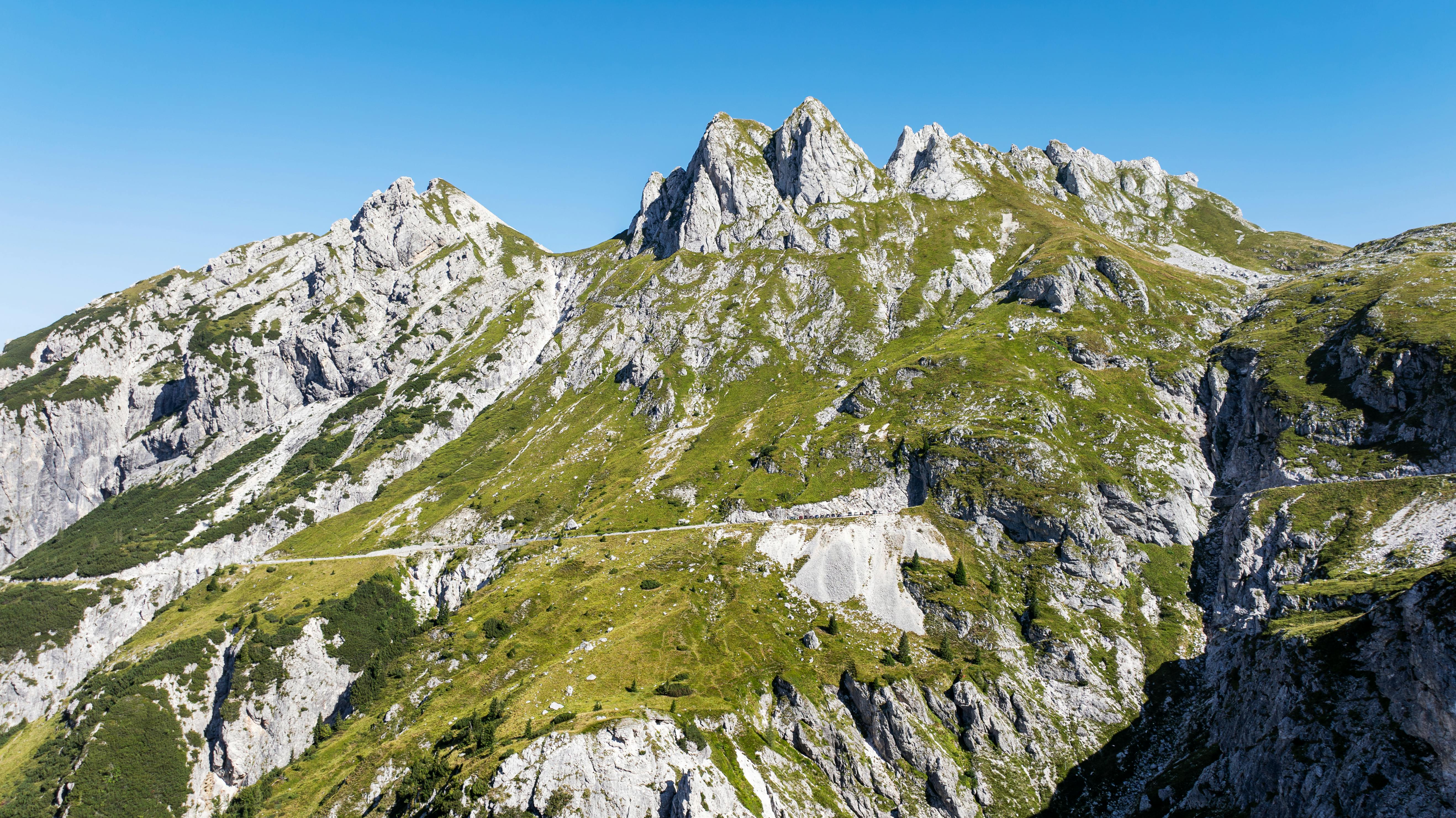 Stunning Mountain Ridges Under Blue Skies · Free Stock Photo