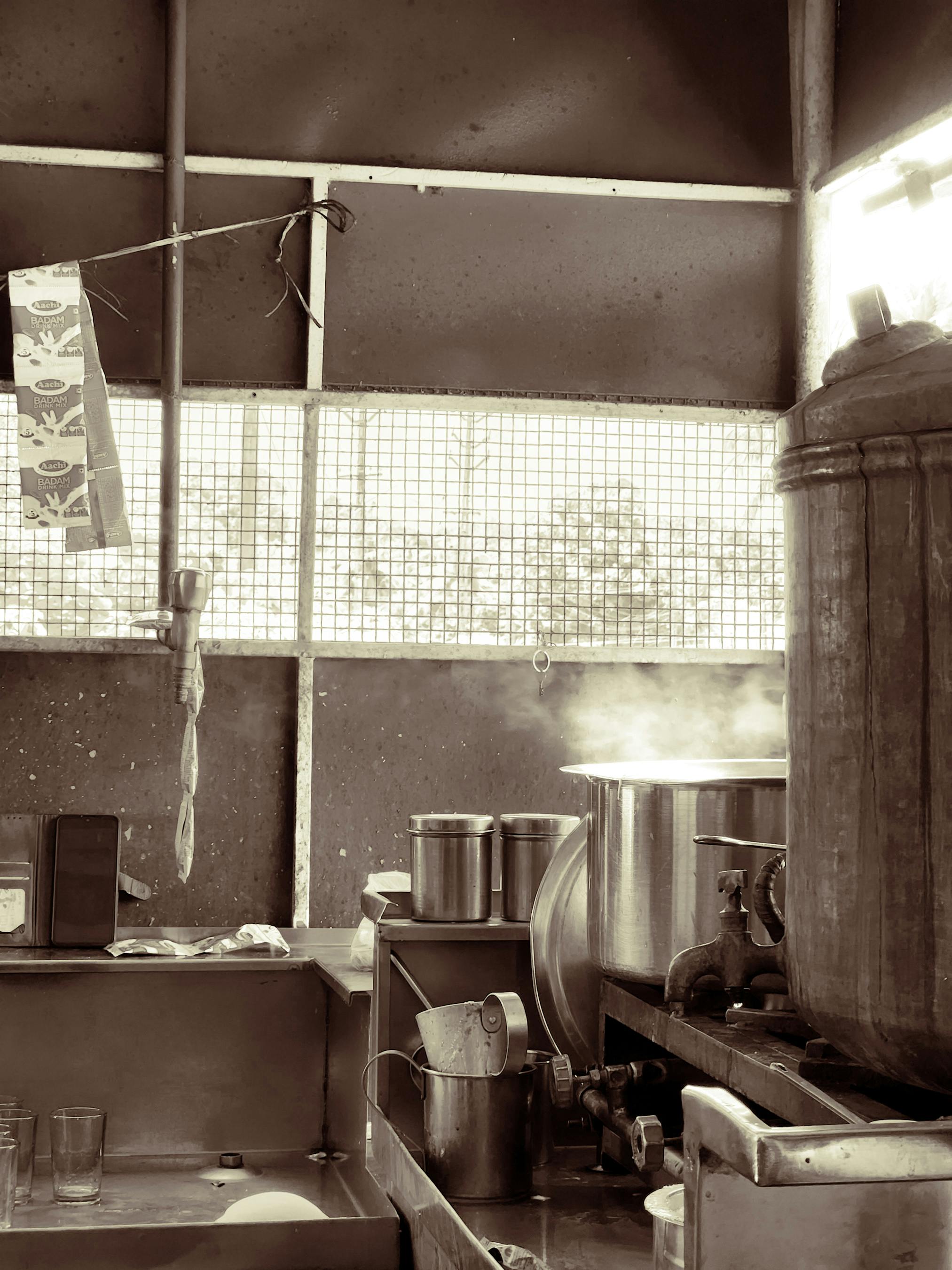 Vintage Kitchen Scene with Steaming Pots · Free Stock Photo