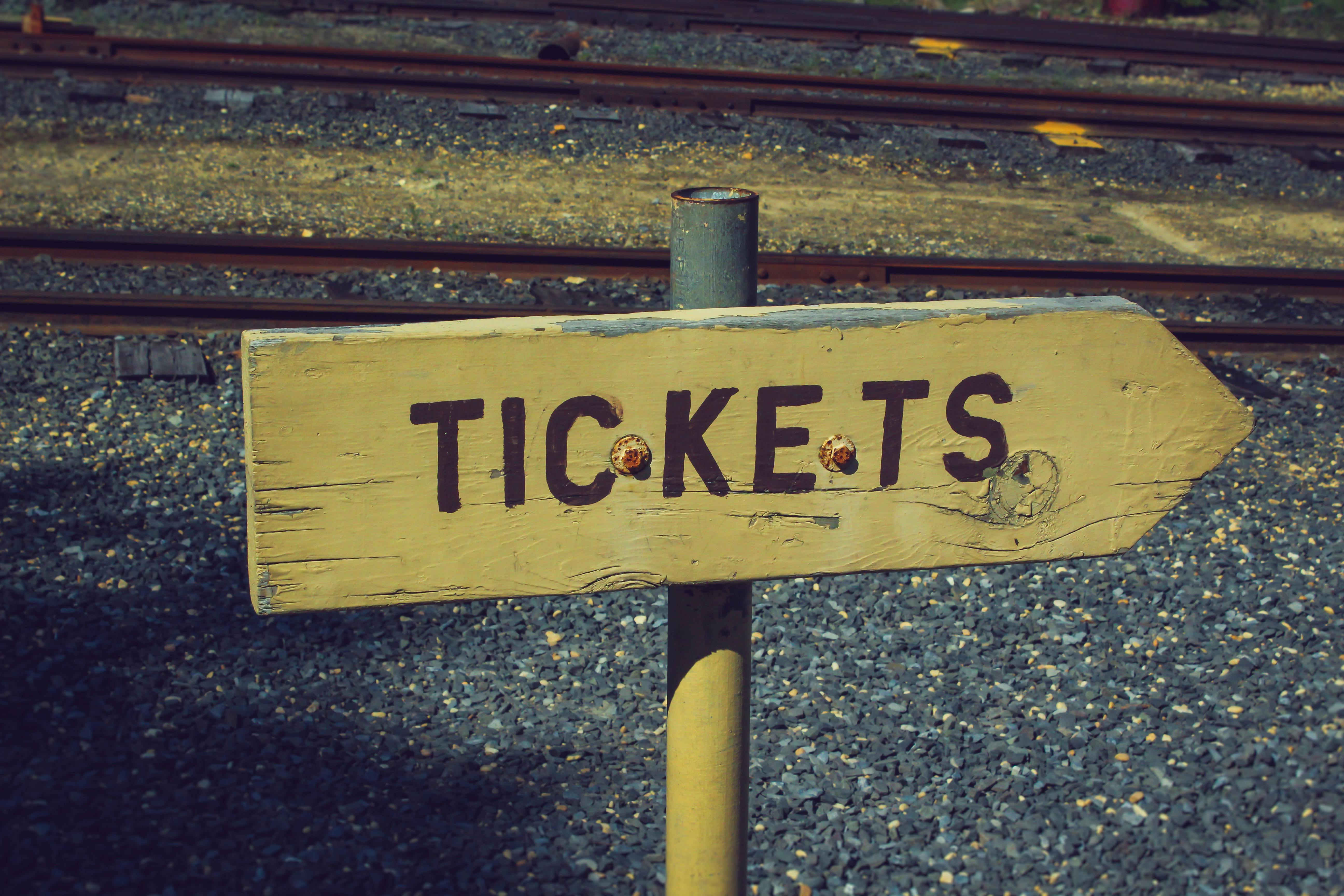 Rustic Ticket Sign by Train Tracks Outdoors · Free Stock Photo