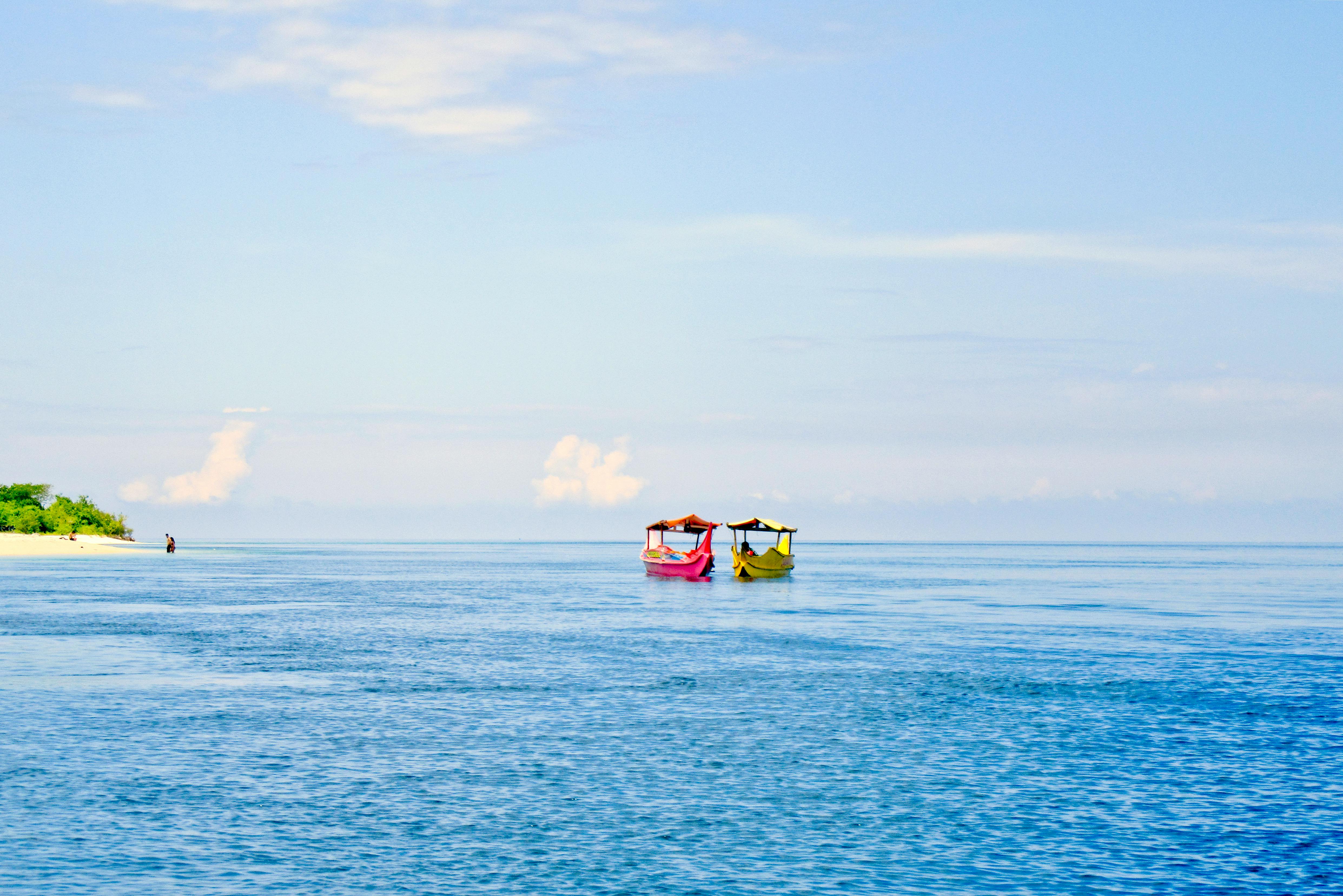Two Colorful Boats On Calm Seas · Free Stock Photo