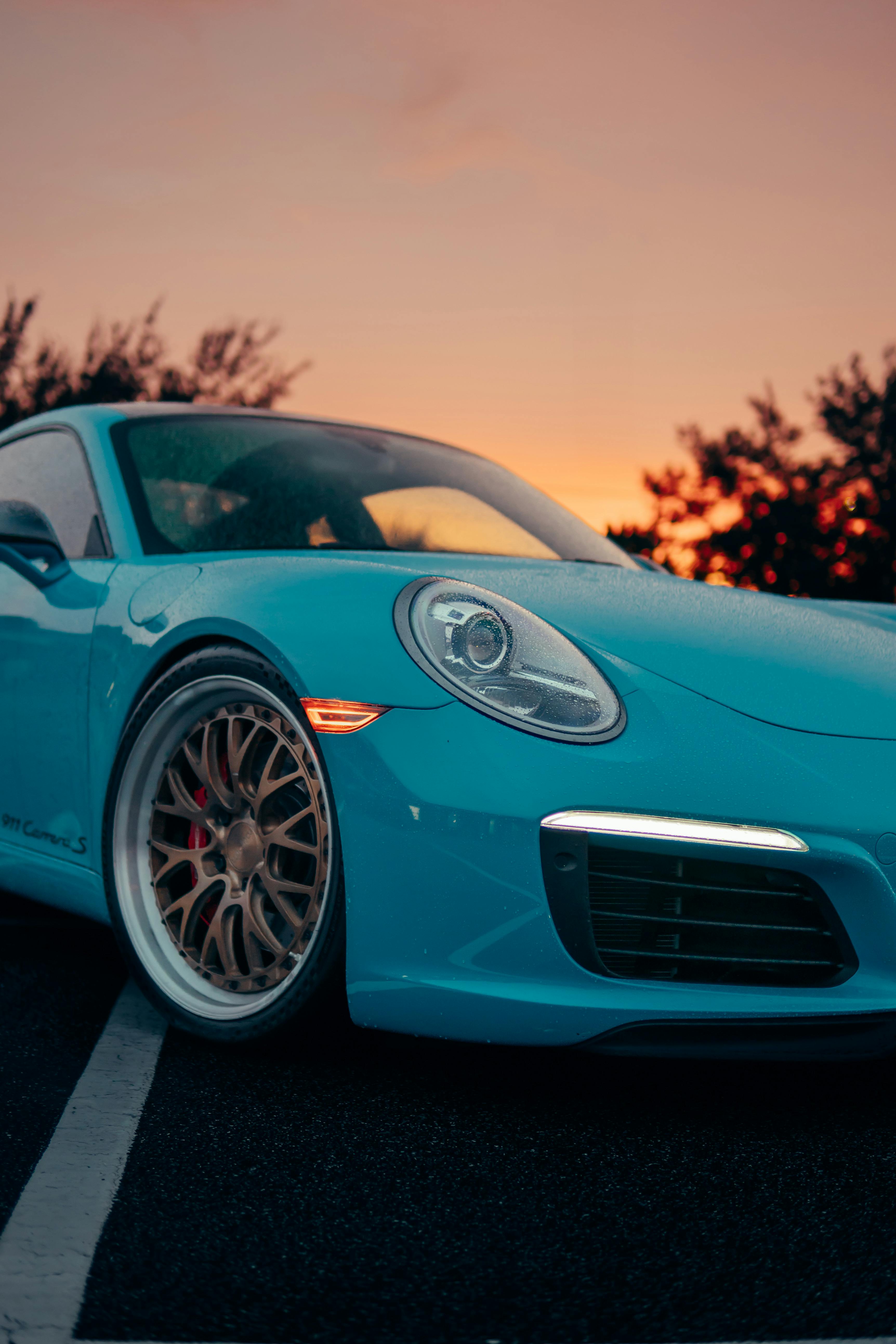 Sleek Blue Sports Car at Sunset · Free Stock Photo