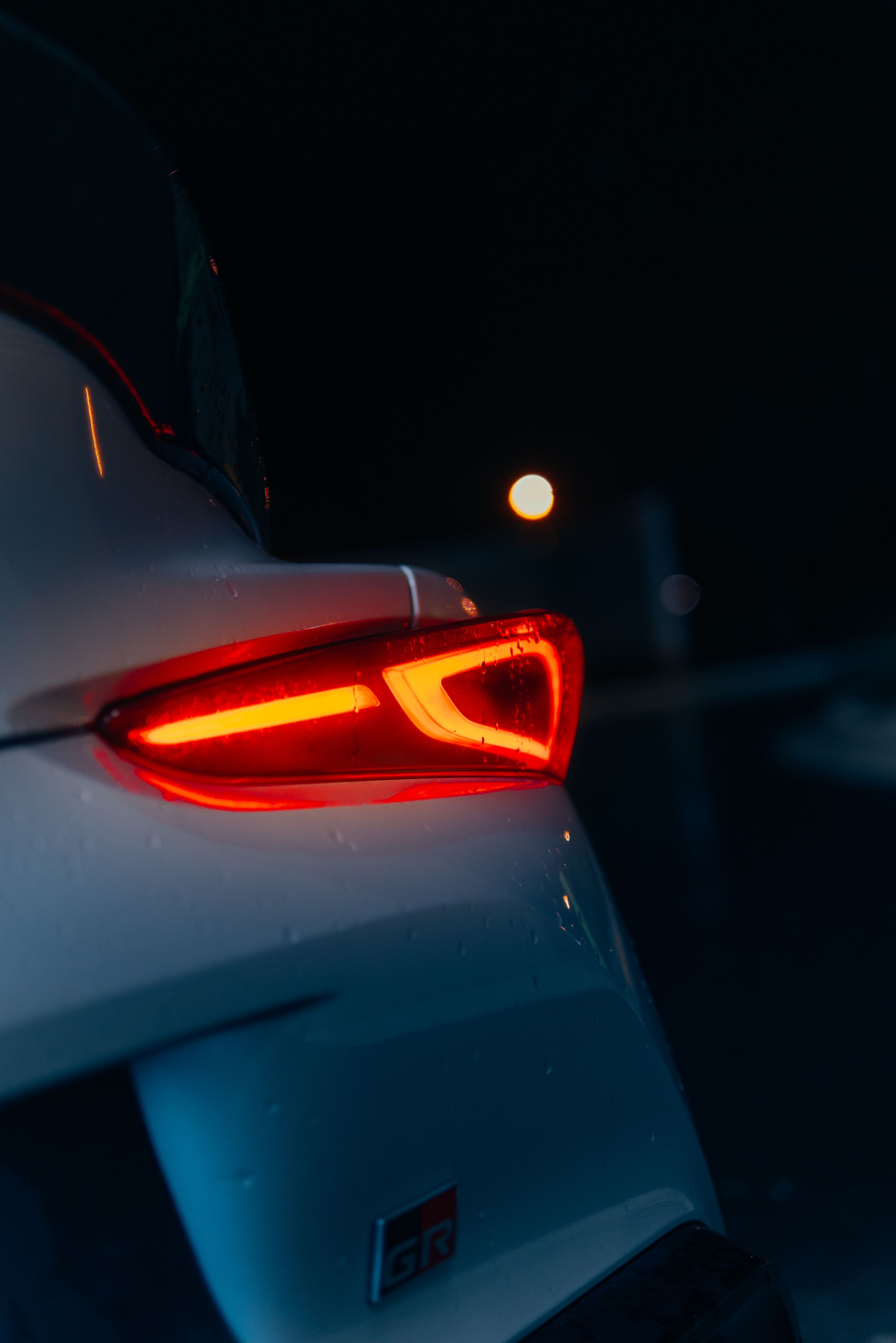 Sleek Car Rear Light with Night Road Reflection · Free Stock Photo