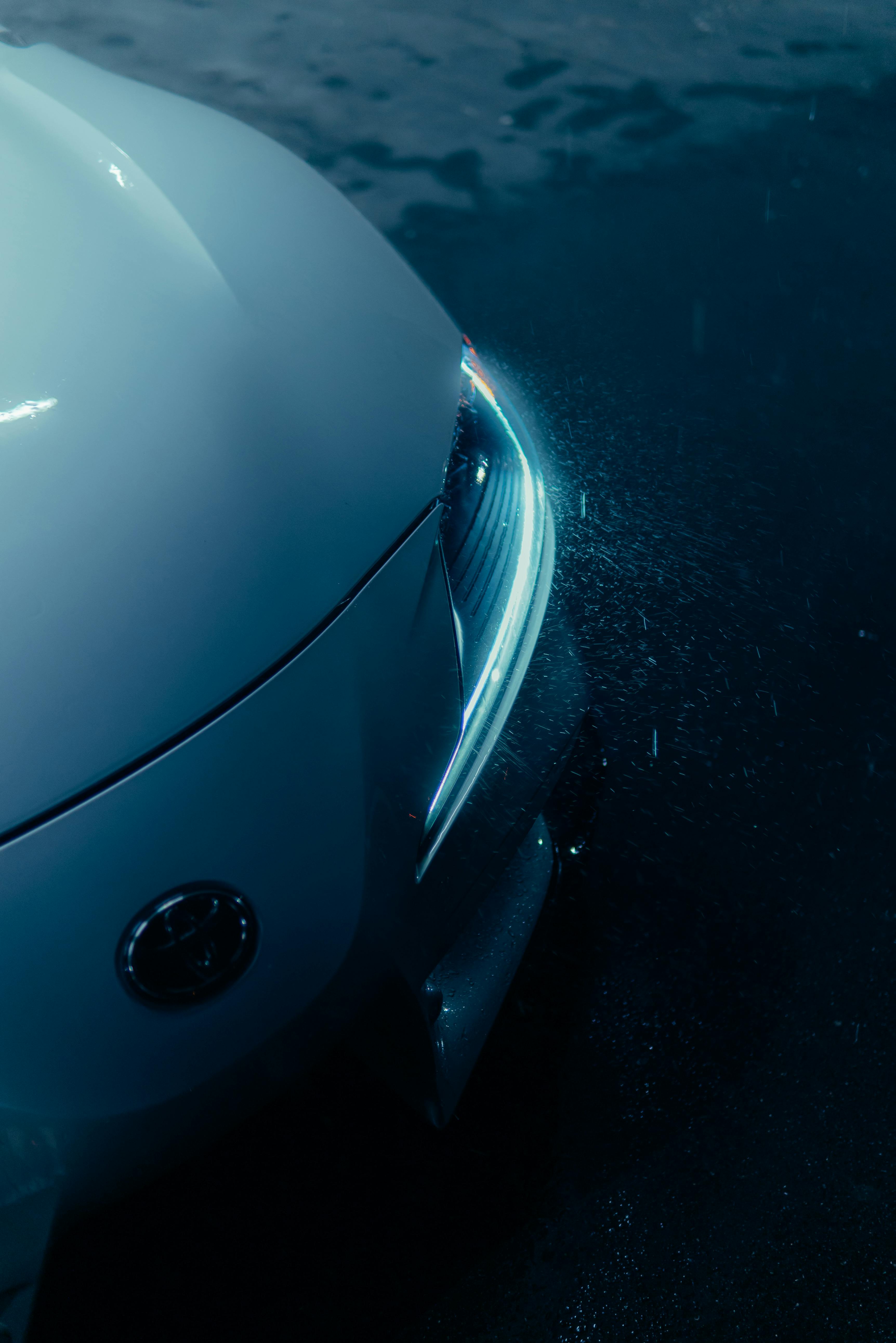 Sleek Car Headlight in Night Rainfall · Free Stock Photo