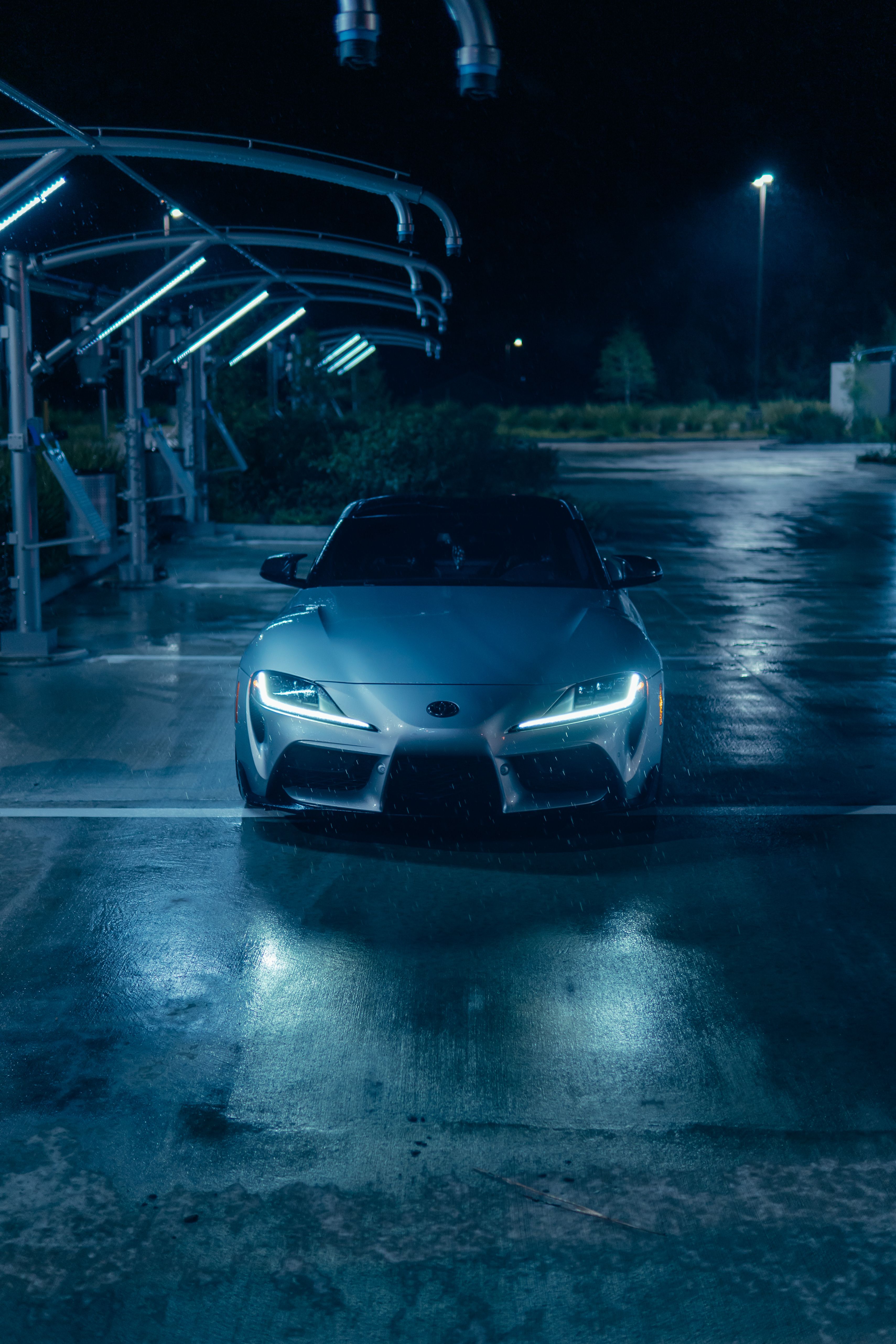 Sleek Modern Car at Night in a Wet Parking Lot · Free Stock Photo