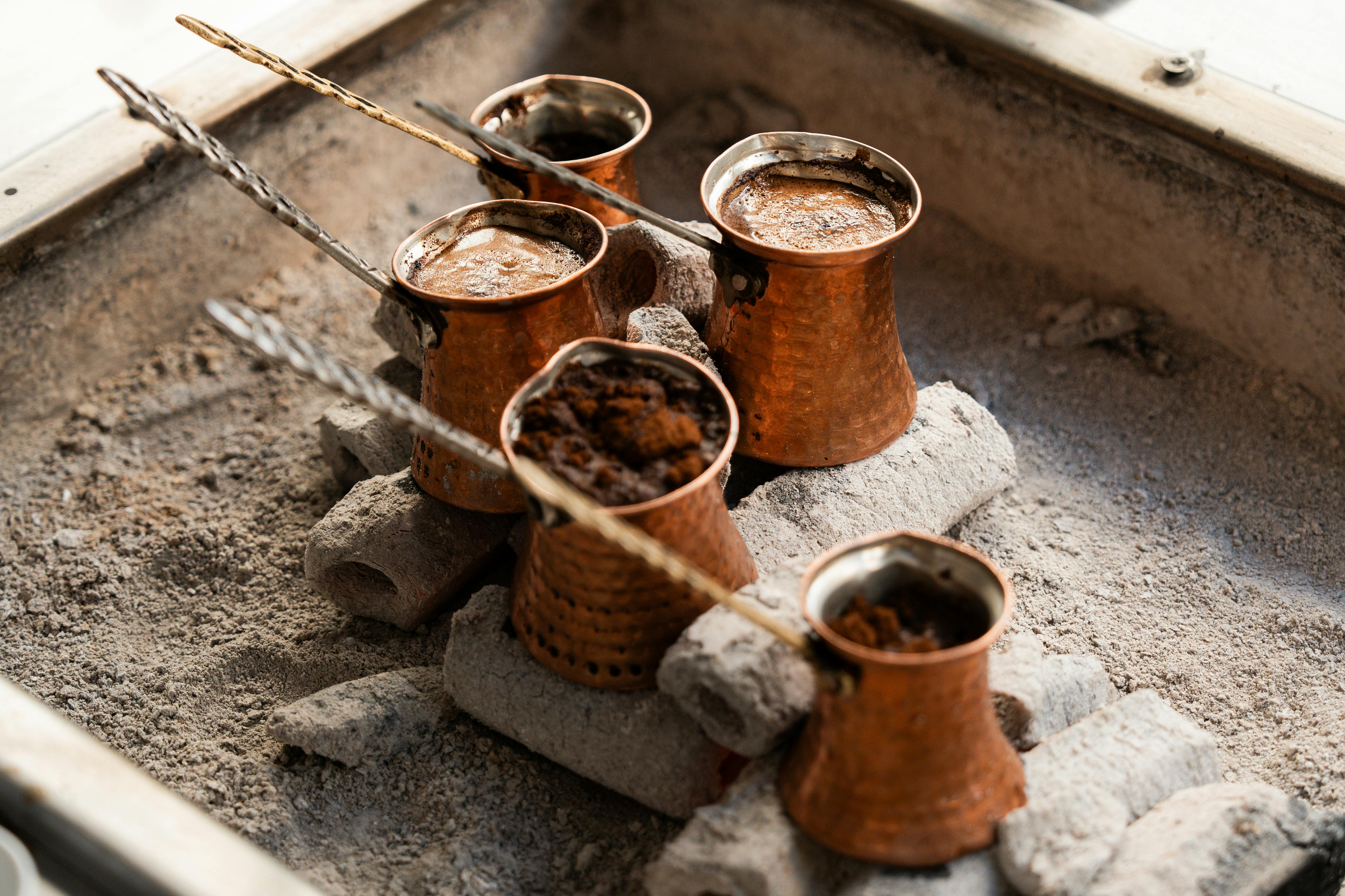 Traditional Turkish Coffee Brewing on Sand · Free Stock Photo