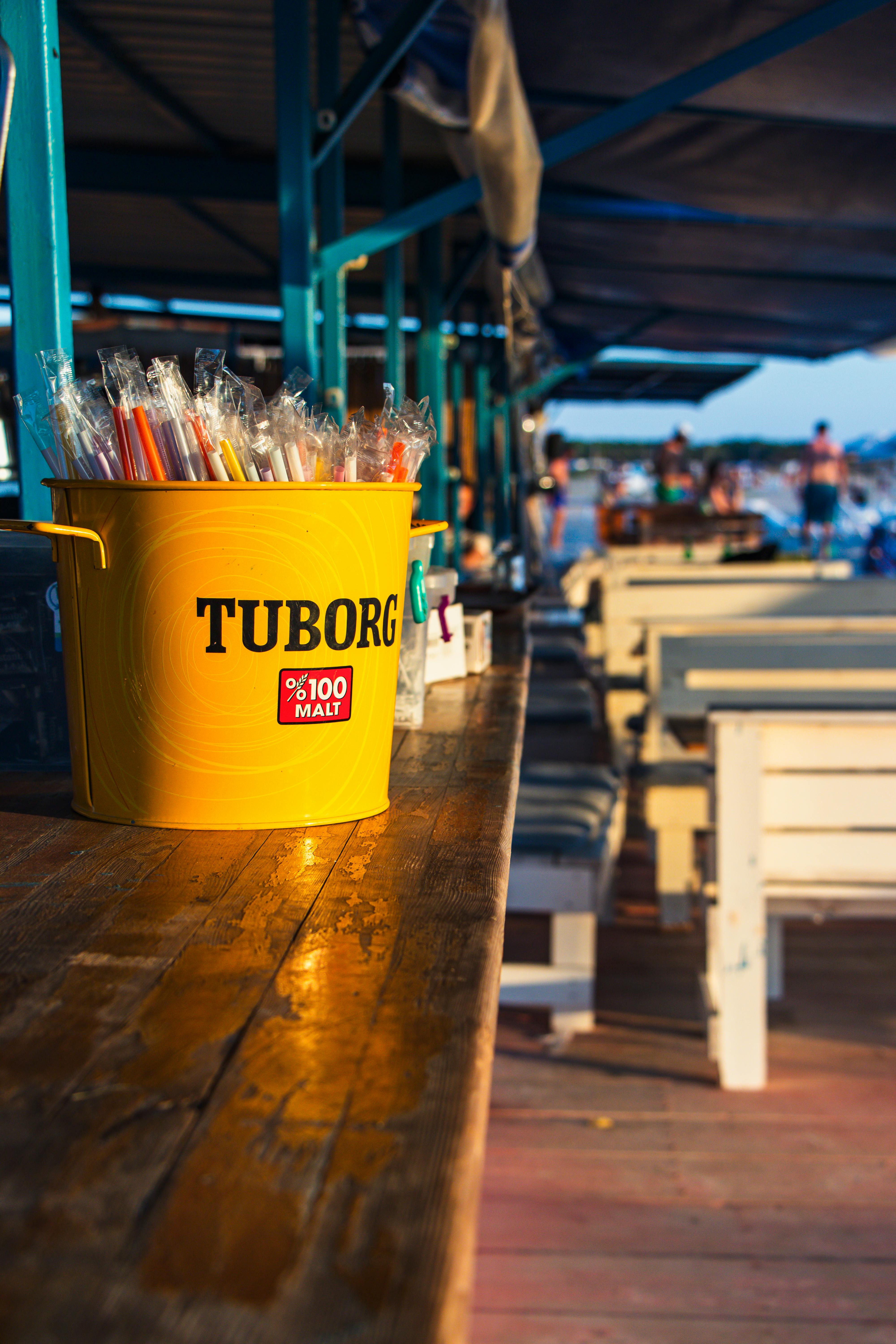 Tuborg bucket on wooden bar in beachfront cafe · Free Stock Photo