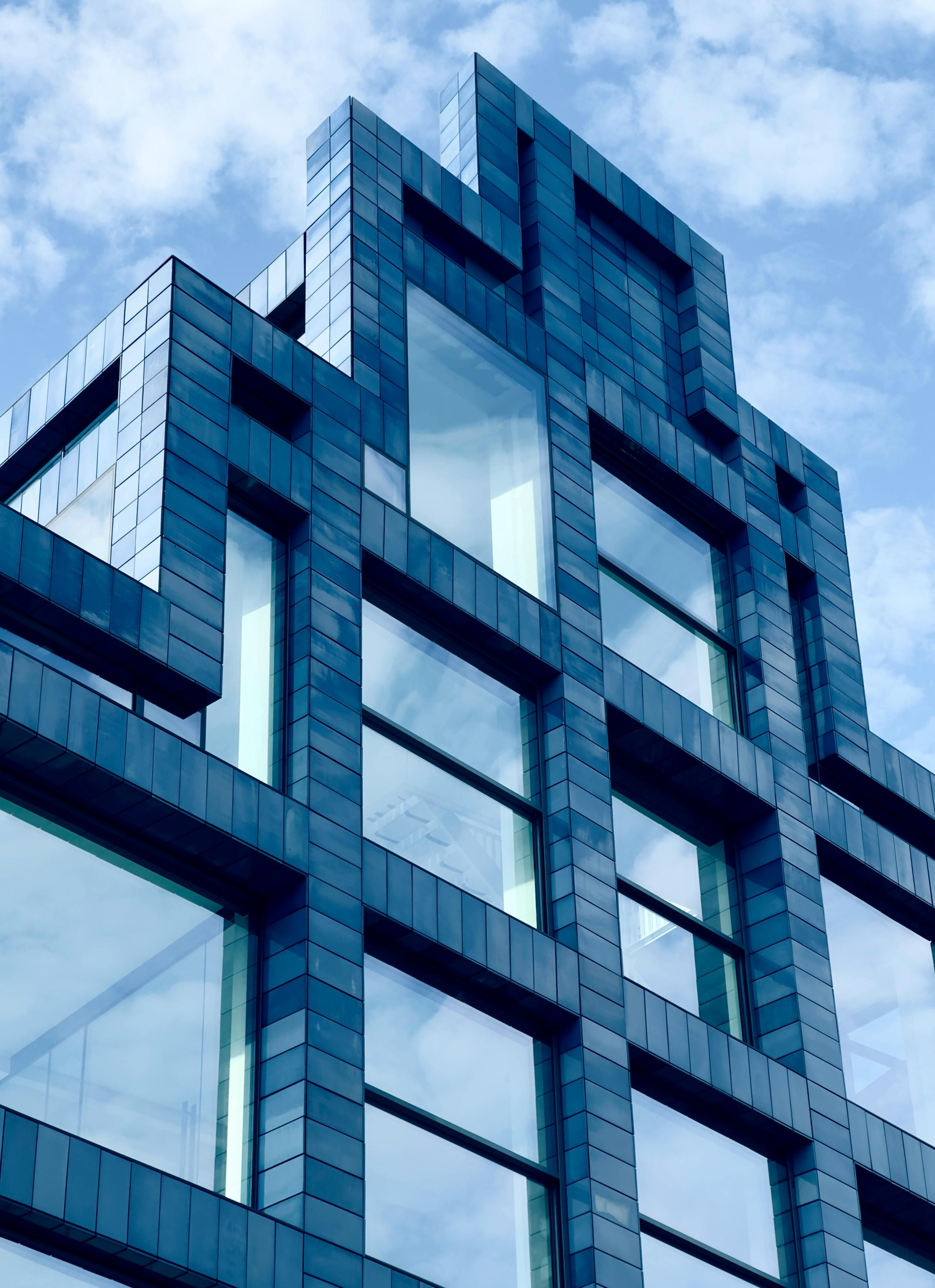Contemporary Glass Building Against Blue Sky · Free Stock Photo