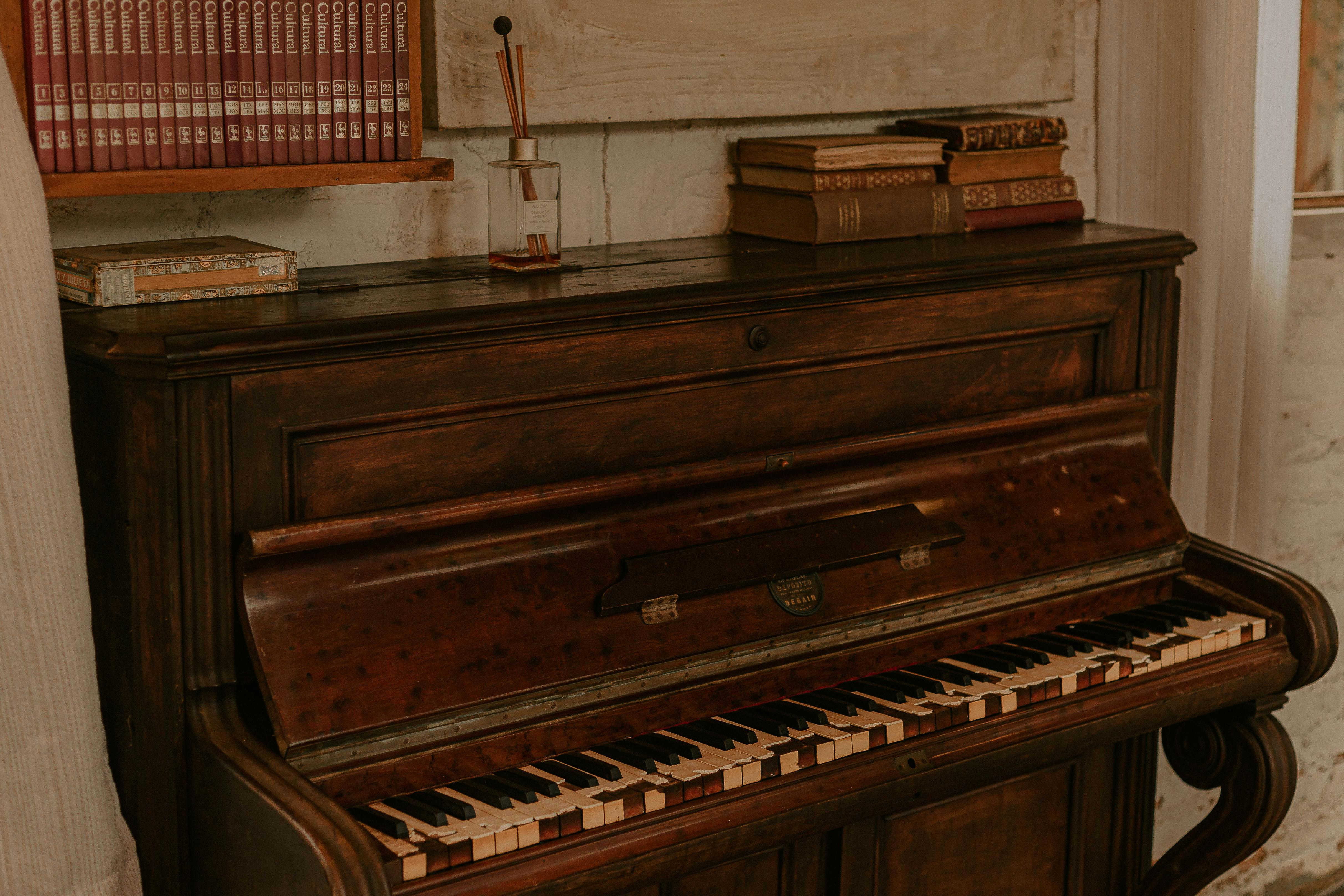 Vintage Piano with Books in Rustic Setting · Free Stock Photo