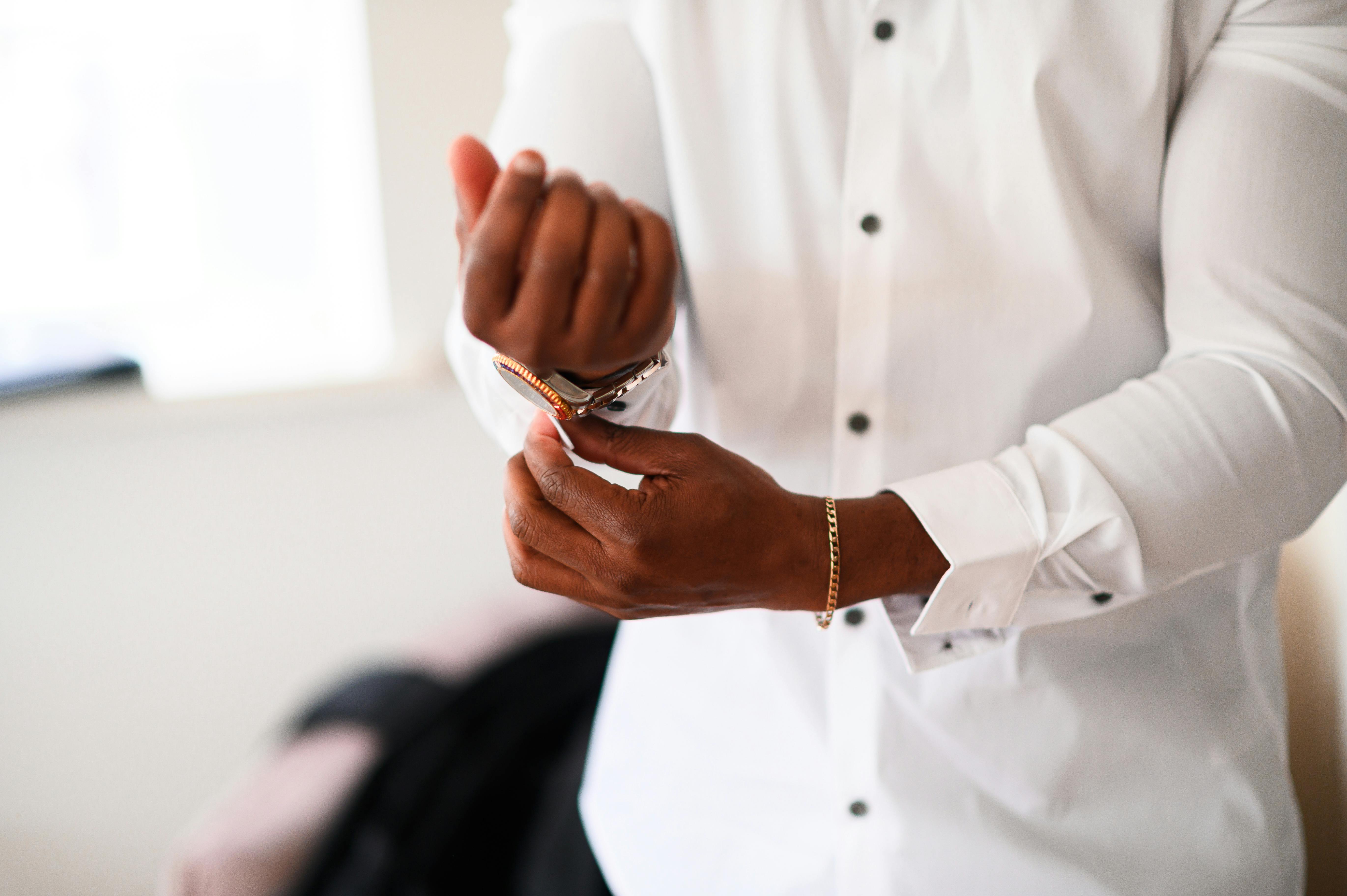 Man Adjusting Cufflinks in White Shirt Close-up · Free Stock Photo