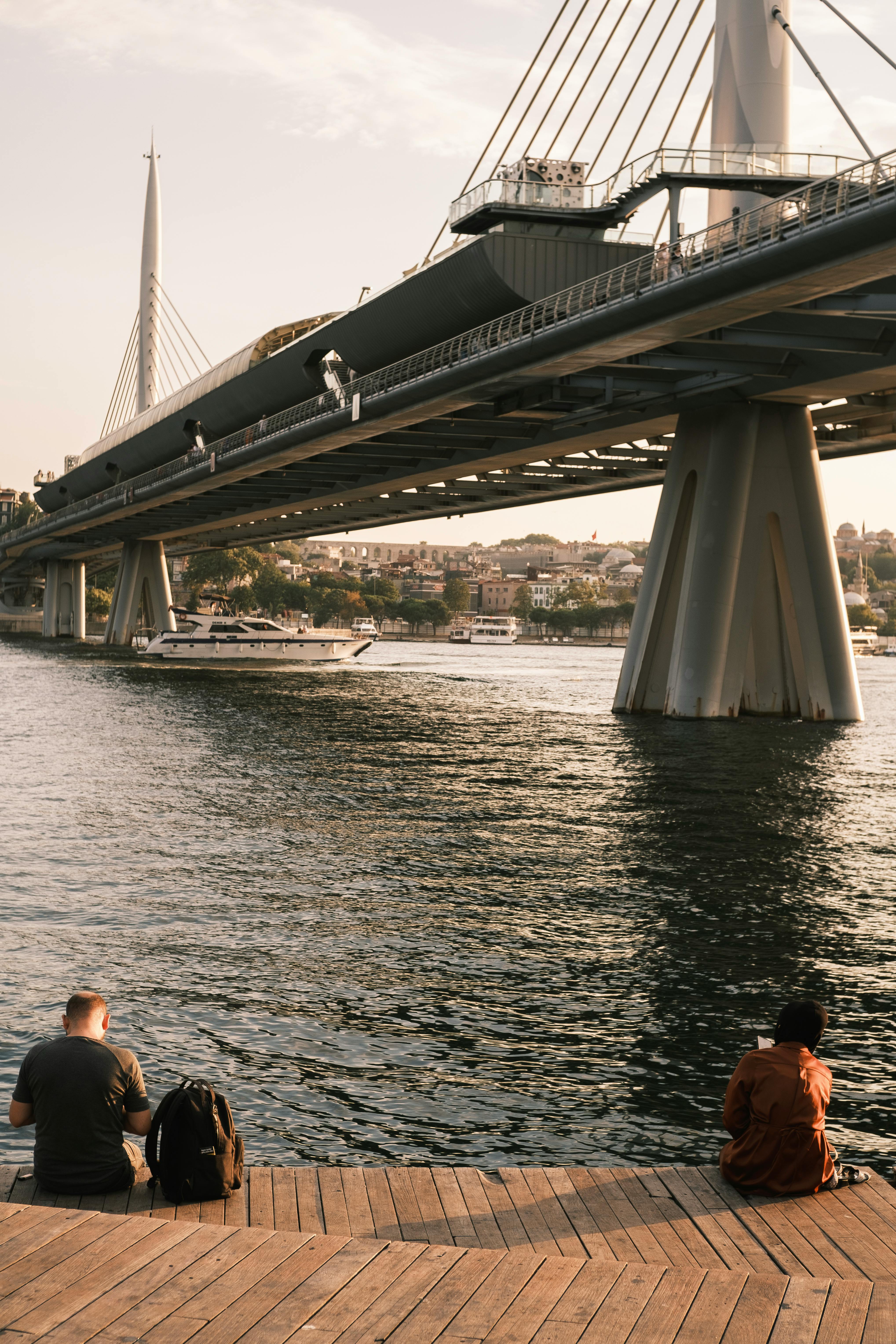 Relaxing by Istanbul's Scenic Waterfront Bridge · Free Stock Photo