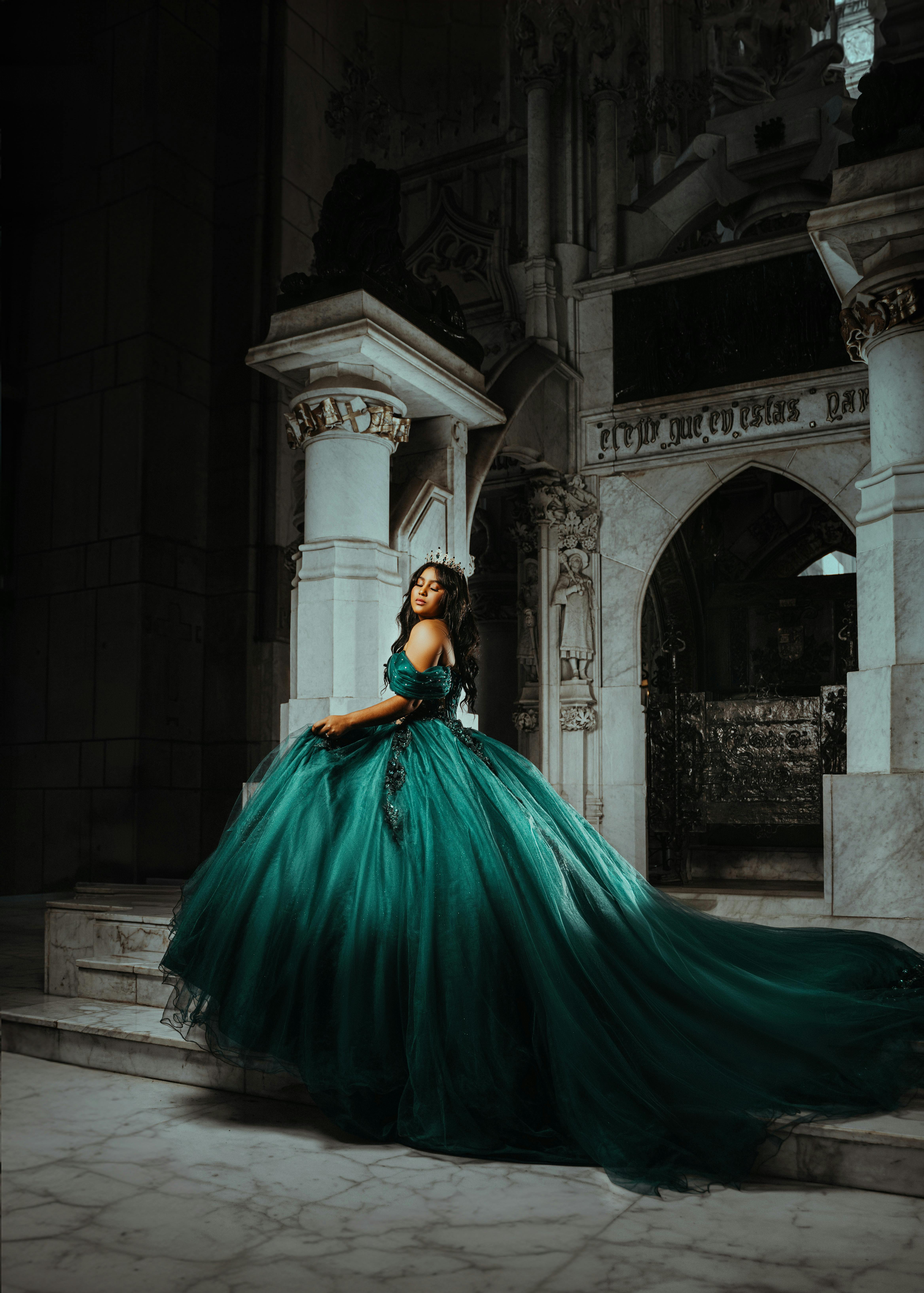 Elegant Woman in Green Gown in Gothic Setting · Free Stock Photo
