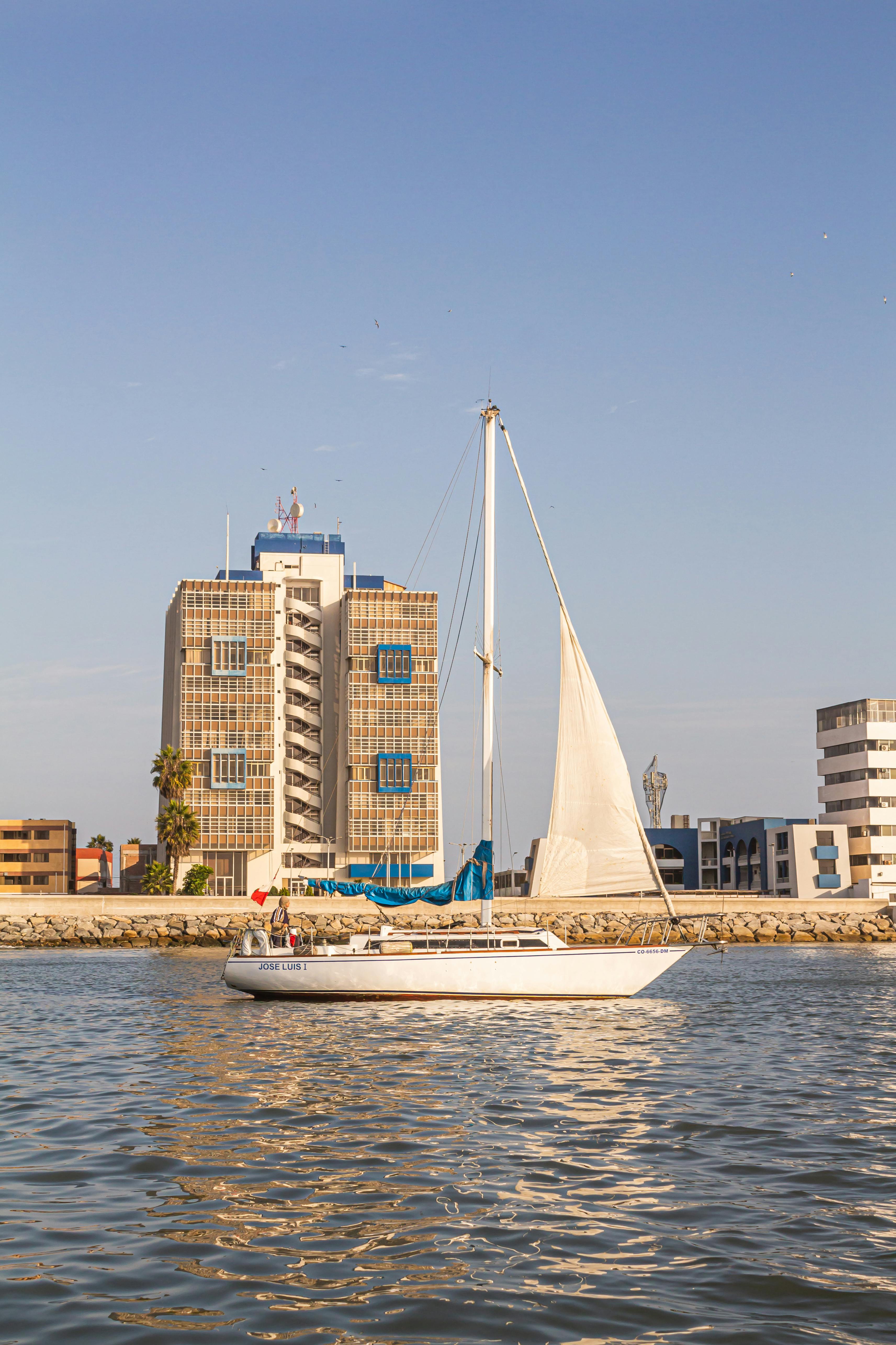 Sailboat in Callao Harbor with Cityscape · Free Stock Photo