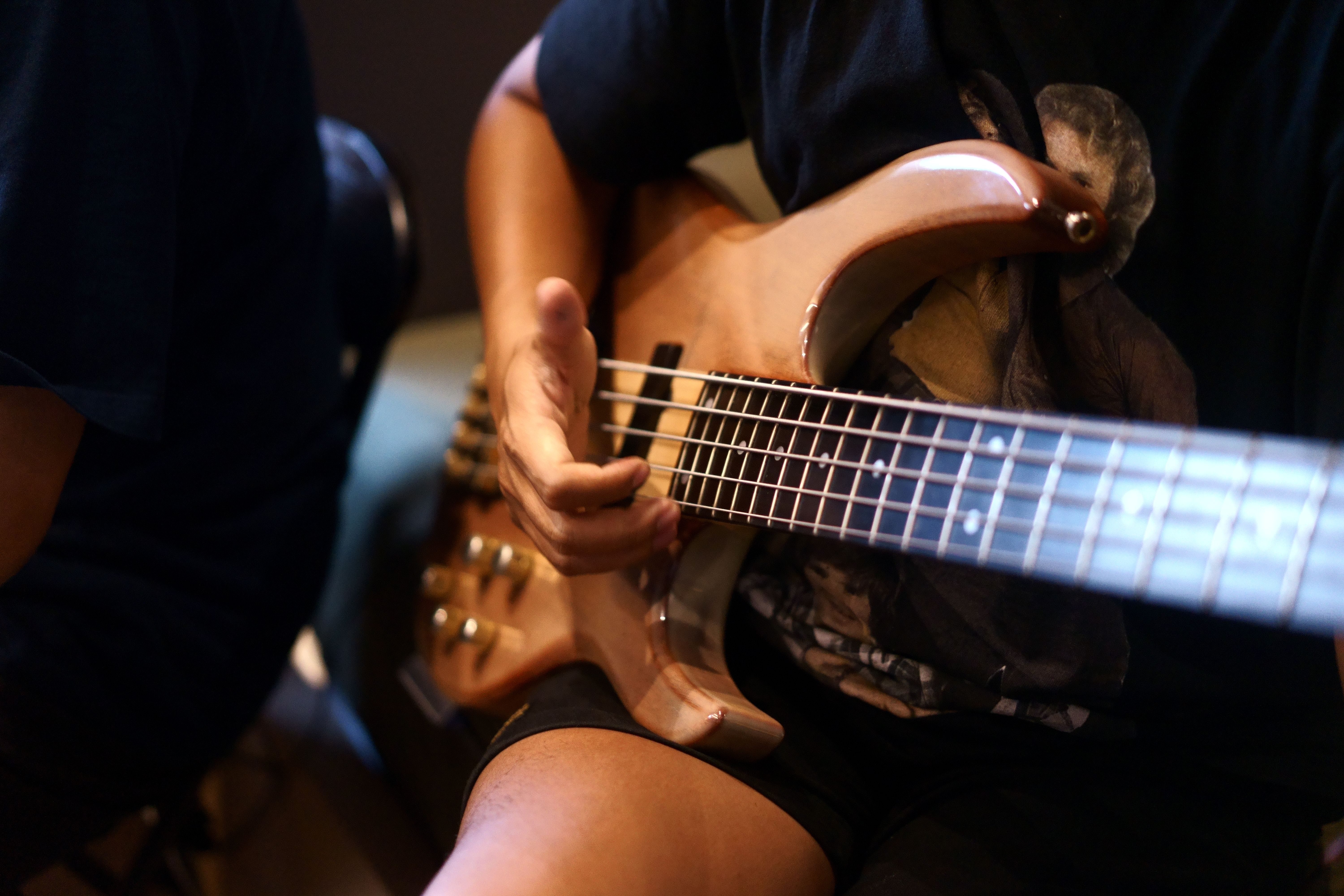 Close-up of Musician Playing Electric Bass Guitar · Free Stock Photo