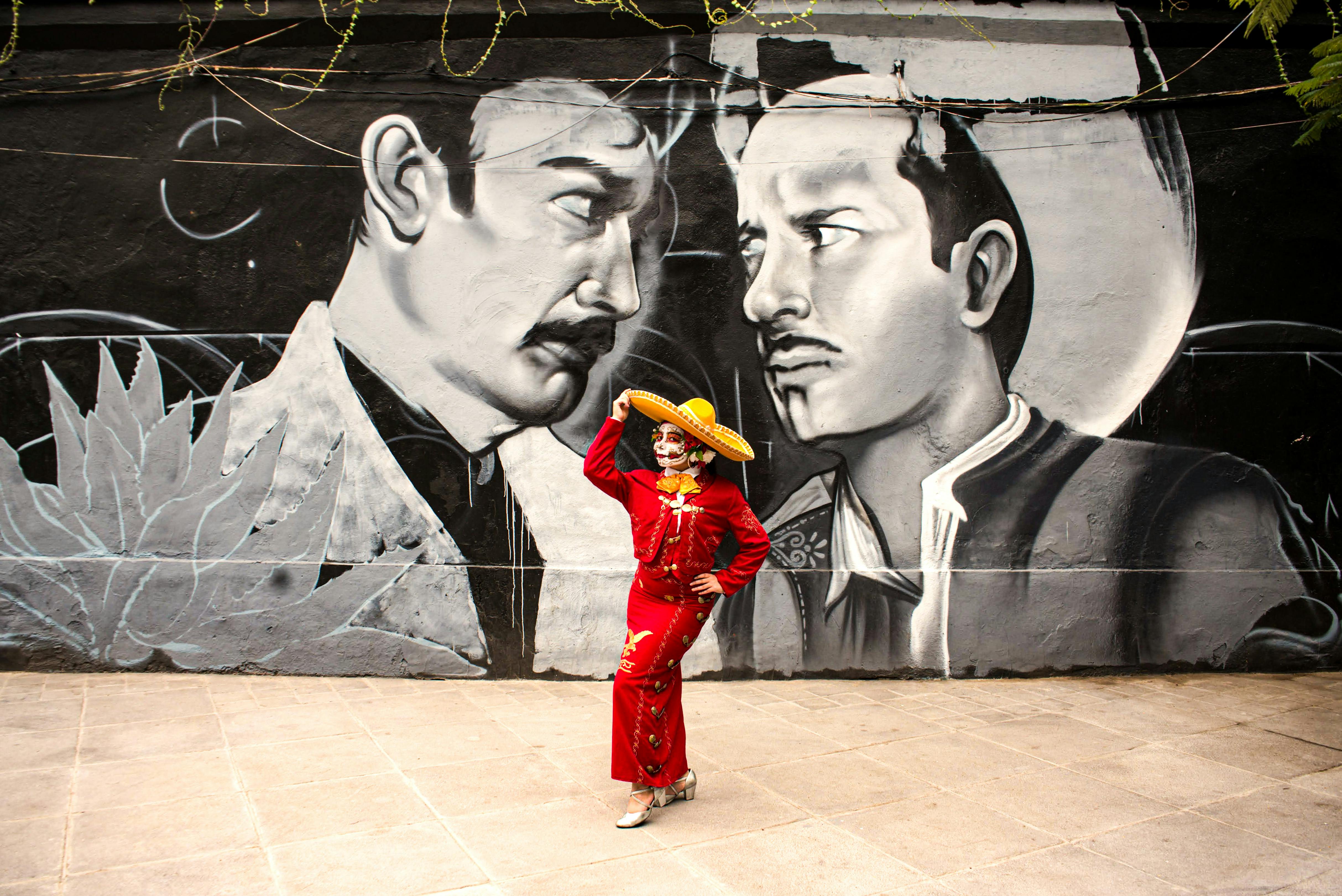 Vibrant Celebration in Front of Iconic Mural · Free Stock Photo