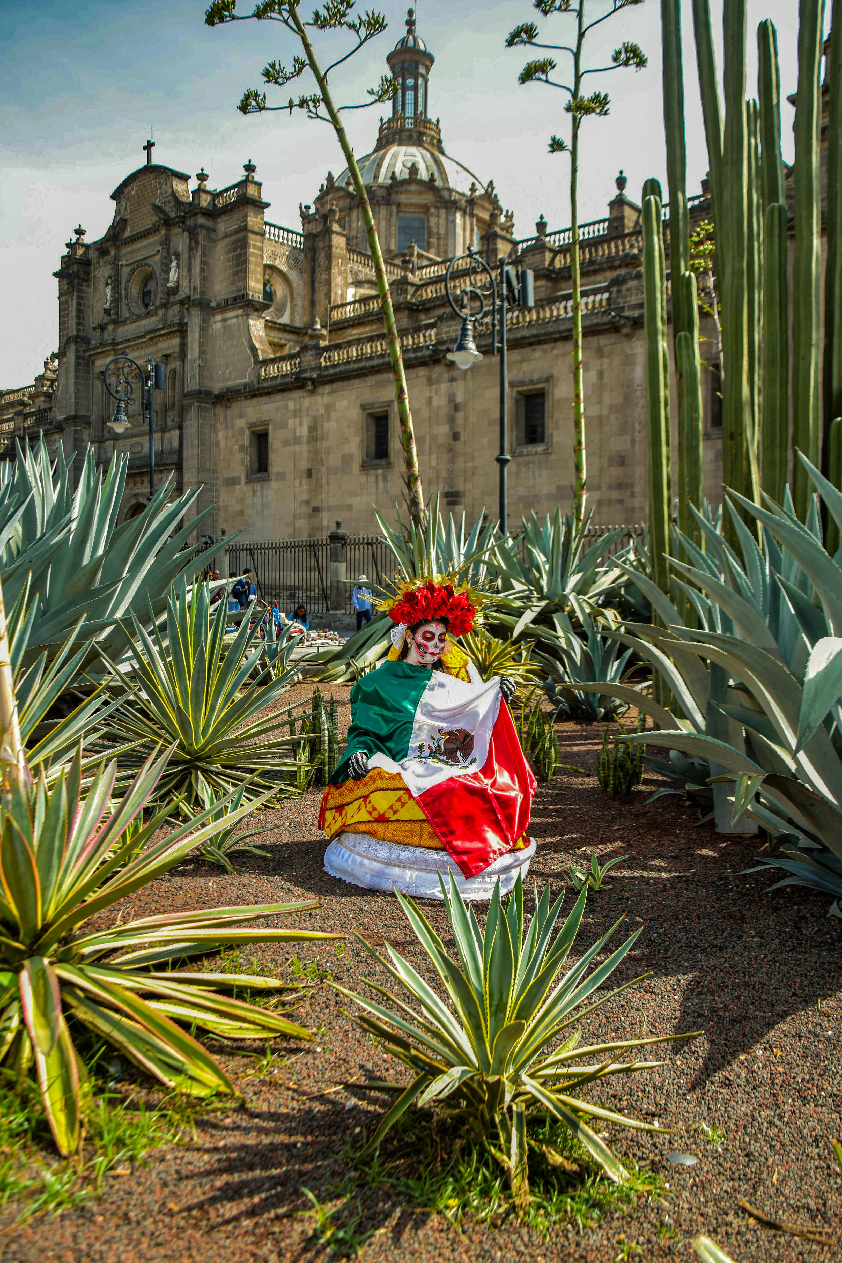 Colorful dancer amidst agave plants and historic architecture · Free ...