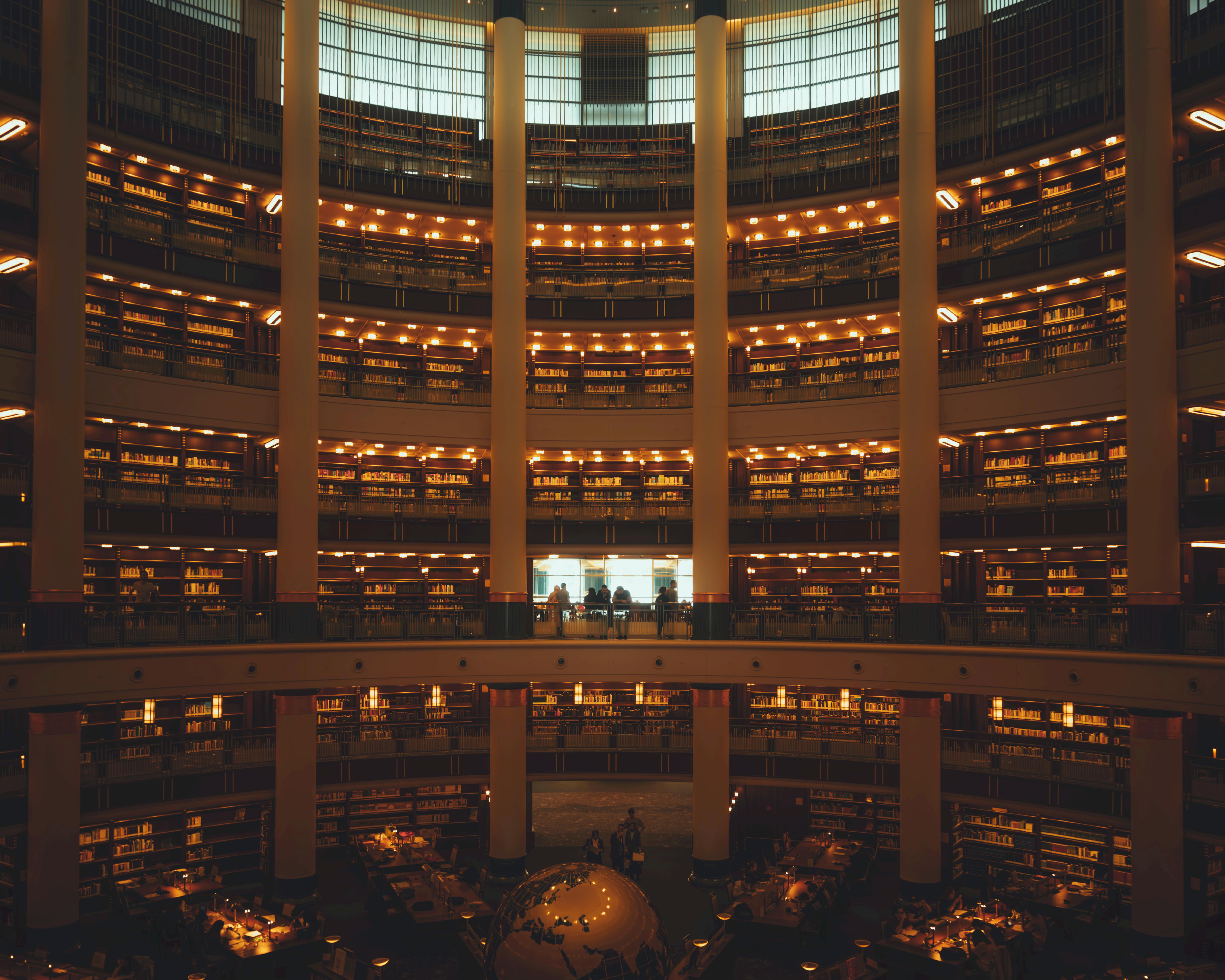 Majestic Library Interior with Warm Lighting · Free Stock Photo