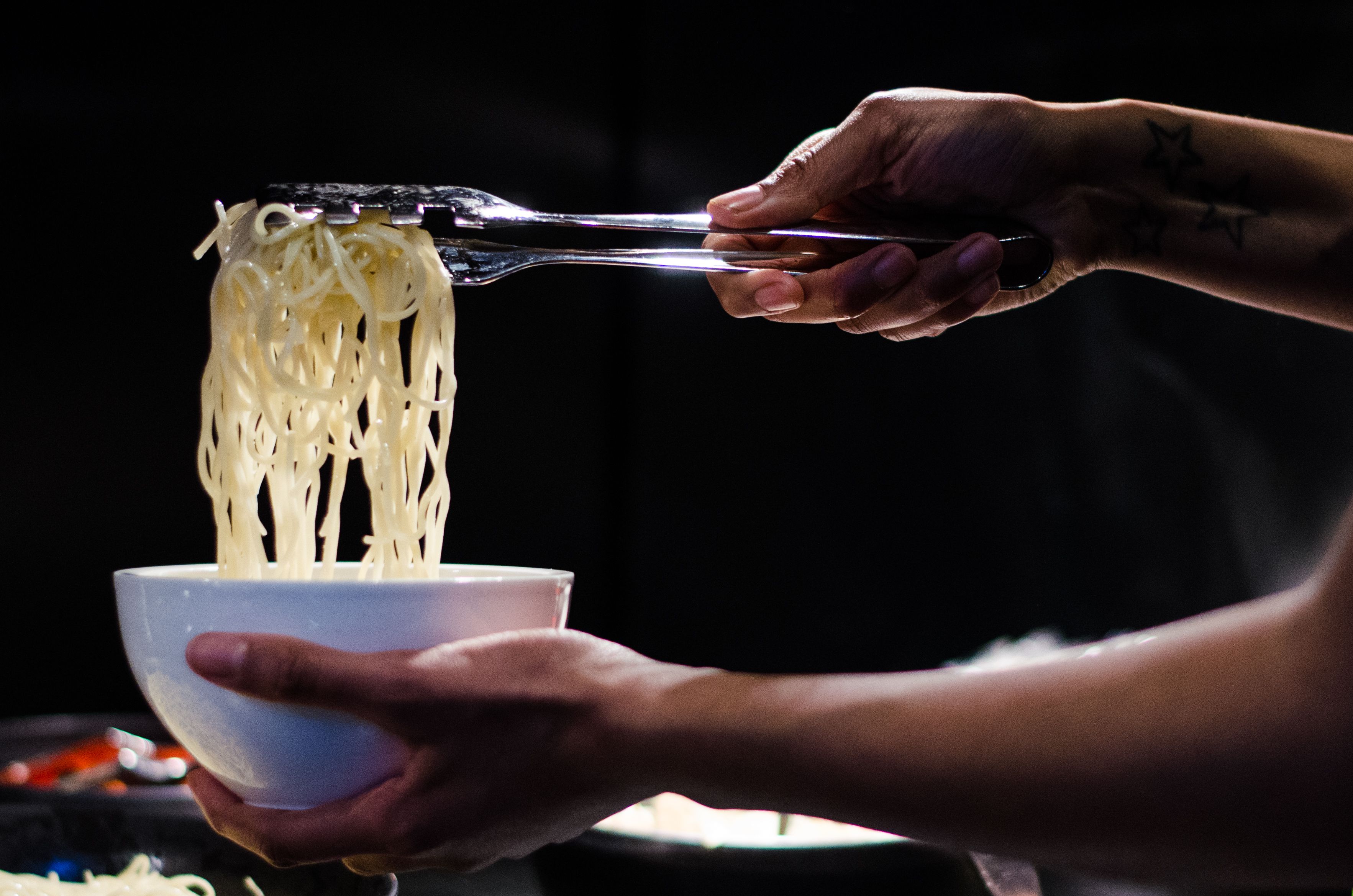 Close-Up of Noodles Being Served in Bowl · Free Stock Photo