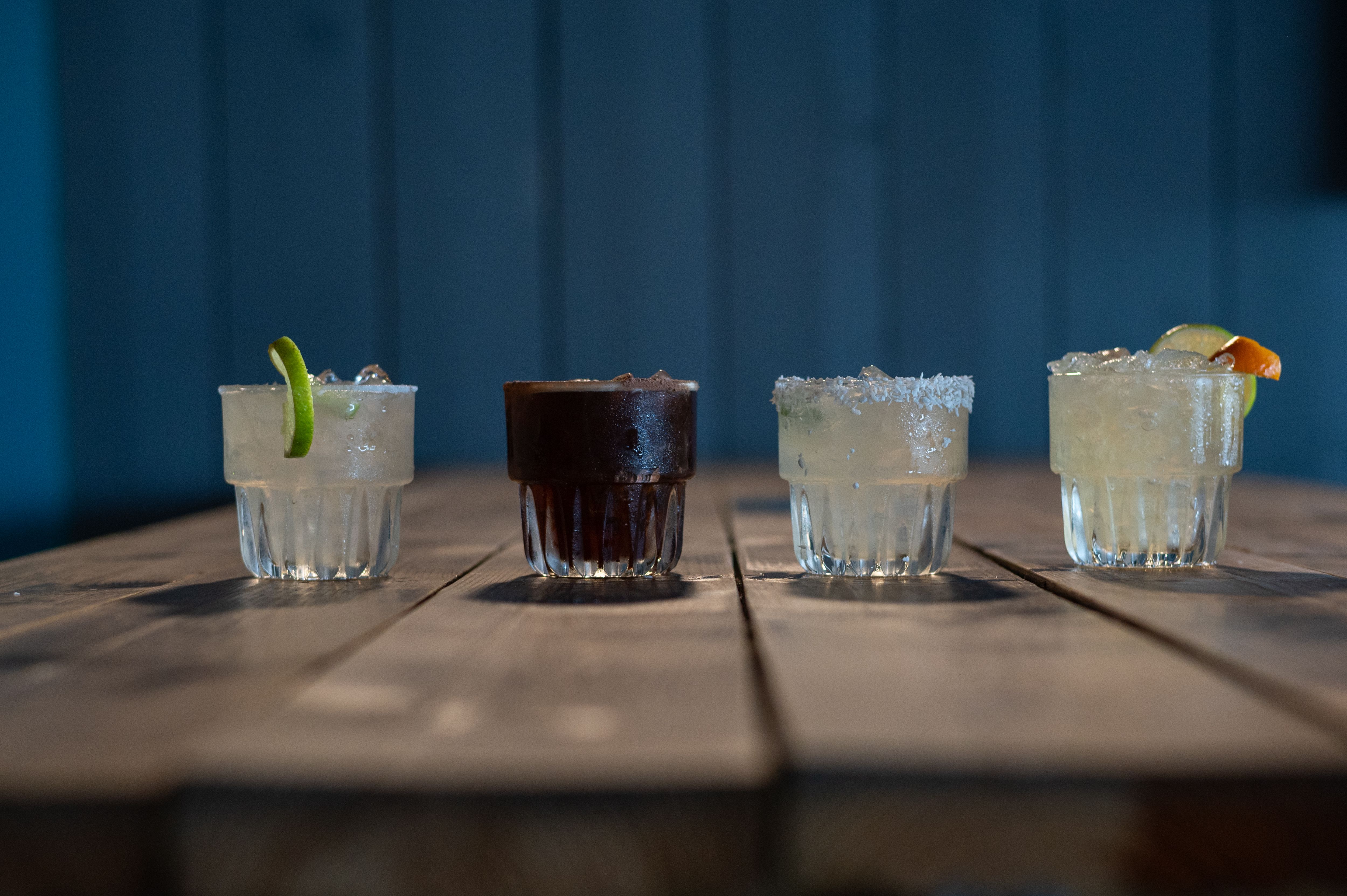 Close-up of Assorted Cocktails on Wooden Table · Free Stock Photo
