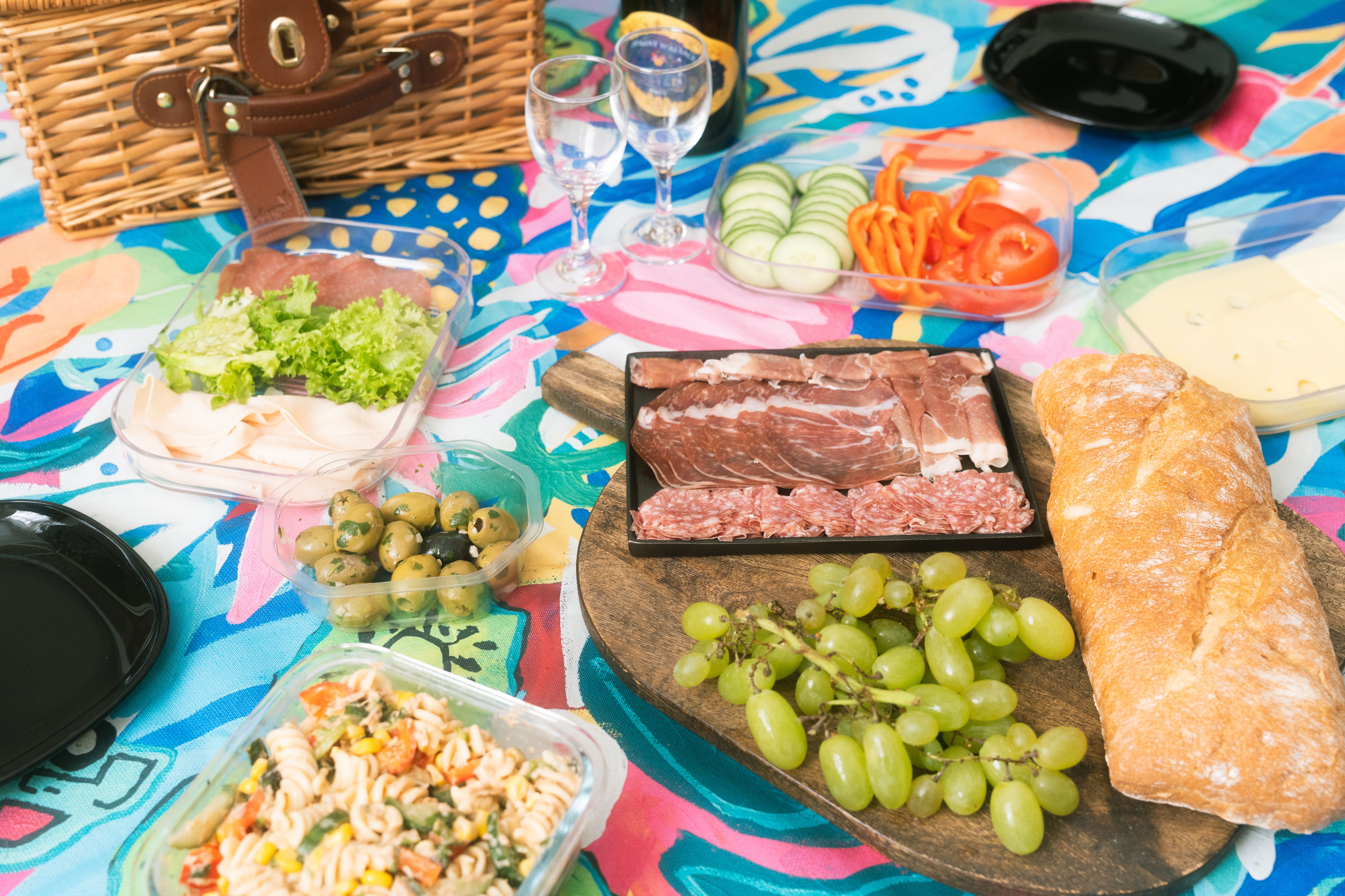 Colorful picnic setup with assorted foods outdoors · Free Stock Photo