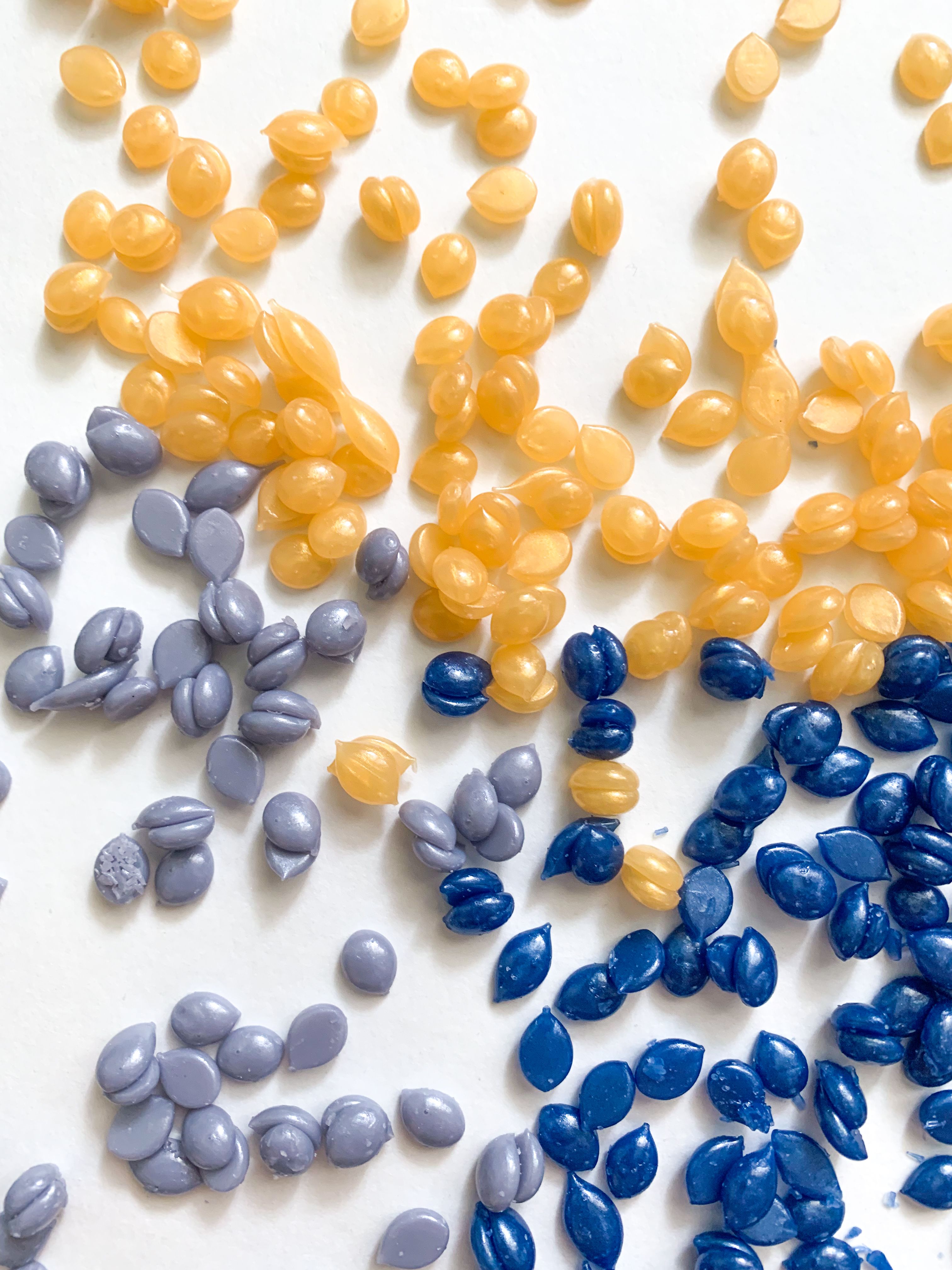 Colorful Wax Beads Flat Lay on White Background · Free Stock Photo