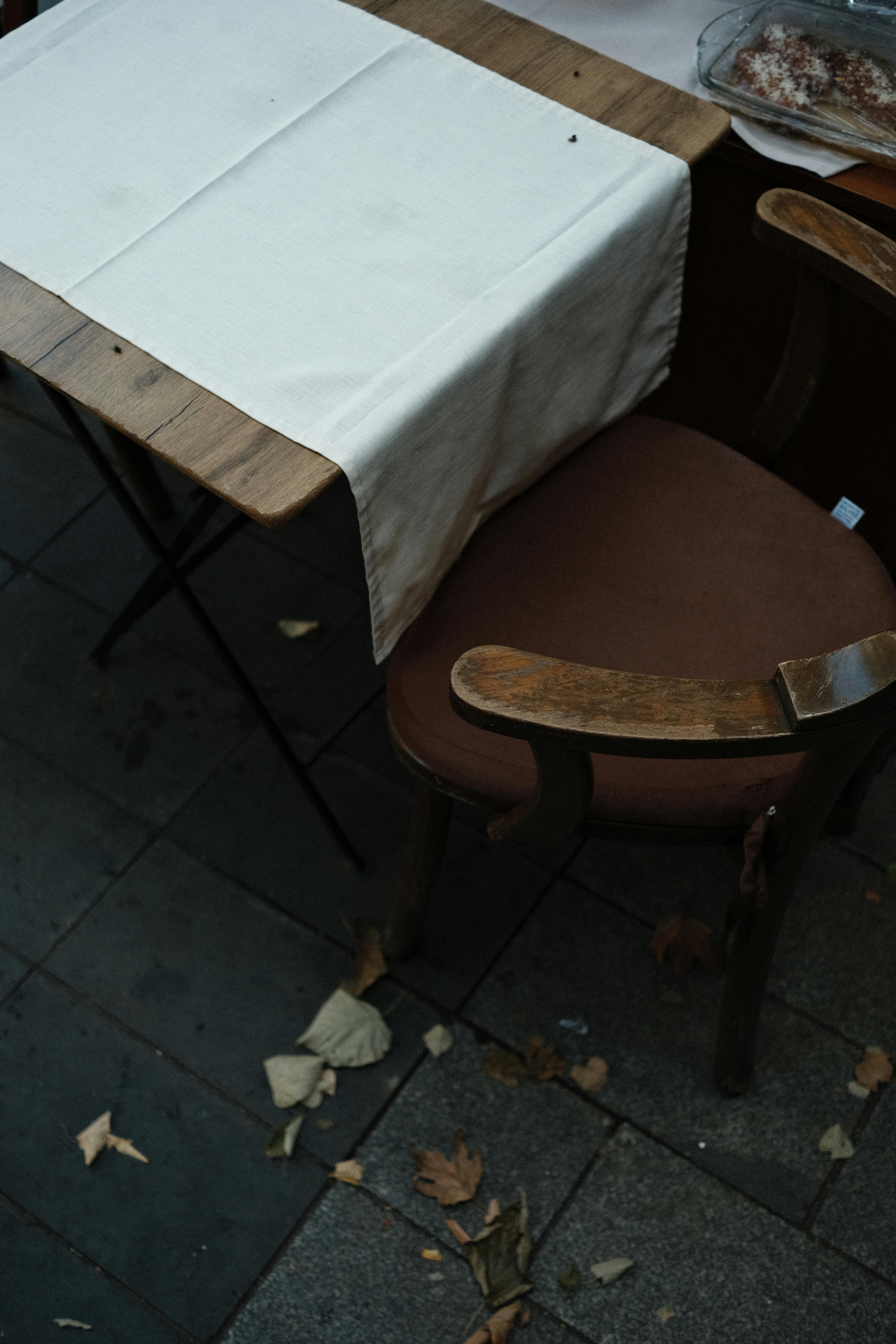 Rustic Outdoor Cafe Table with Autumn Leaves · Free Stock Photo