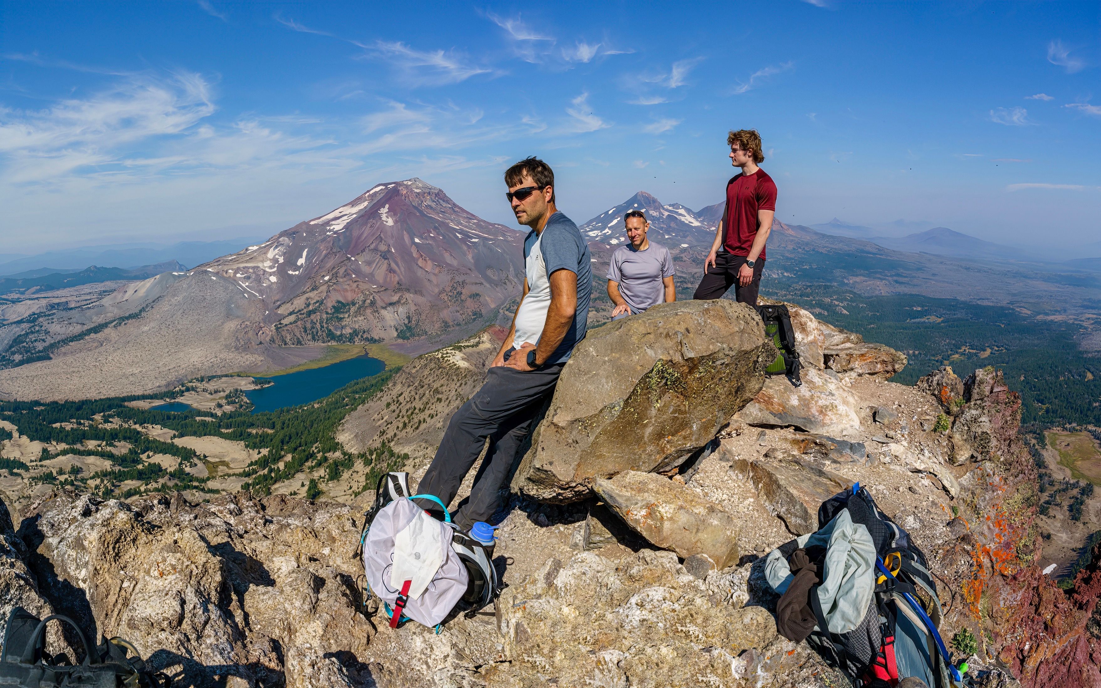 Hikers Enjoy Scenic View from Mountain Peak · Free Stock Photo