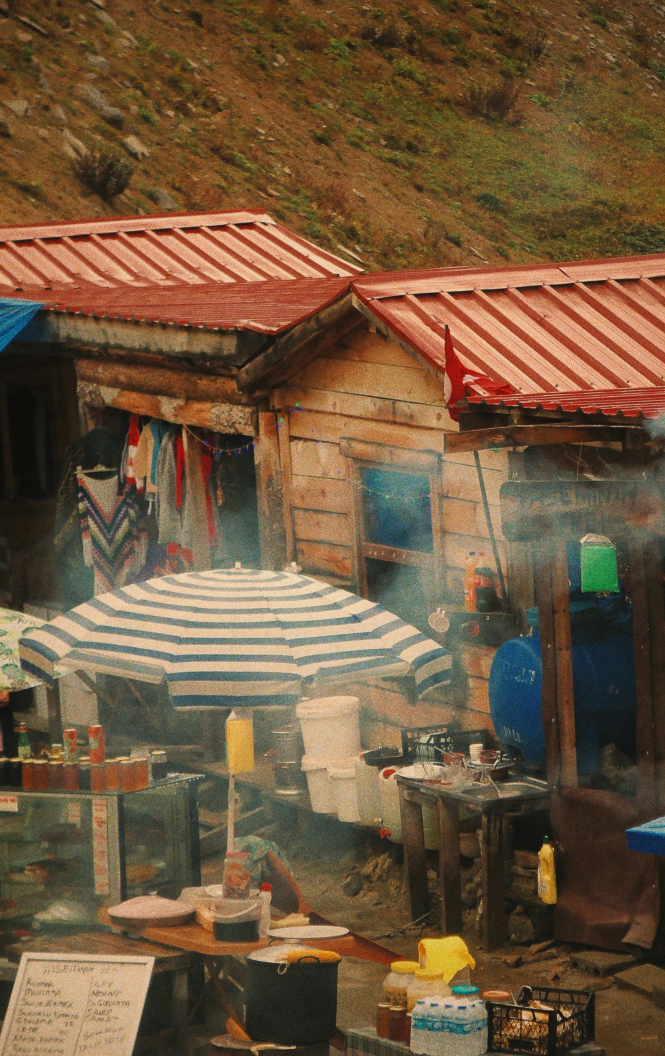 Rustic Market Stalls with Vibrant Umbrella Scene · Free Stock Photo
