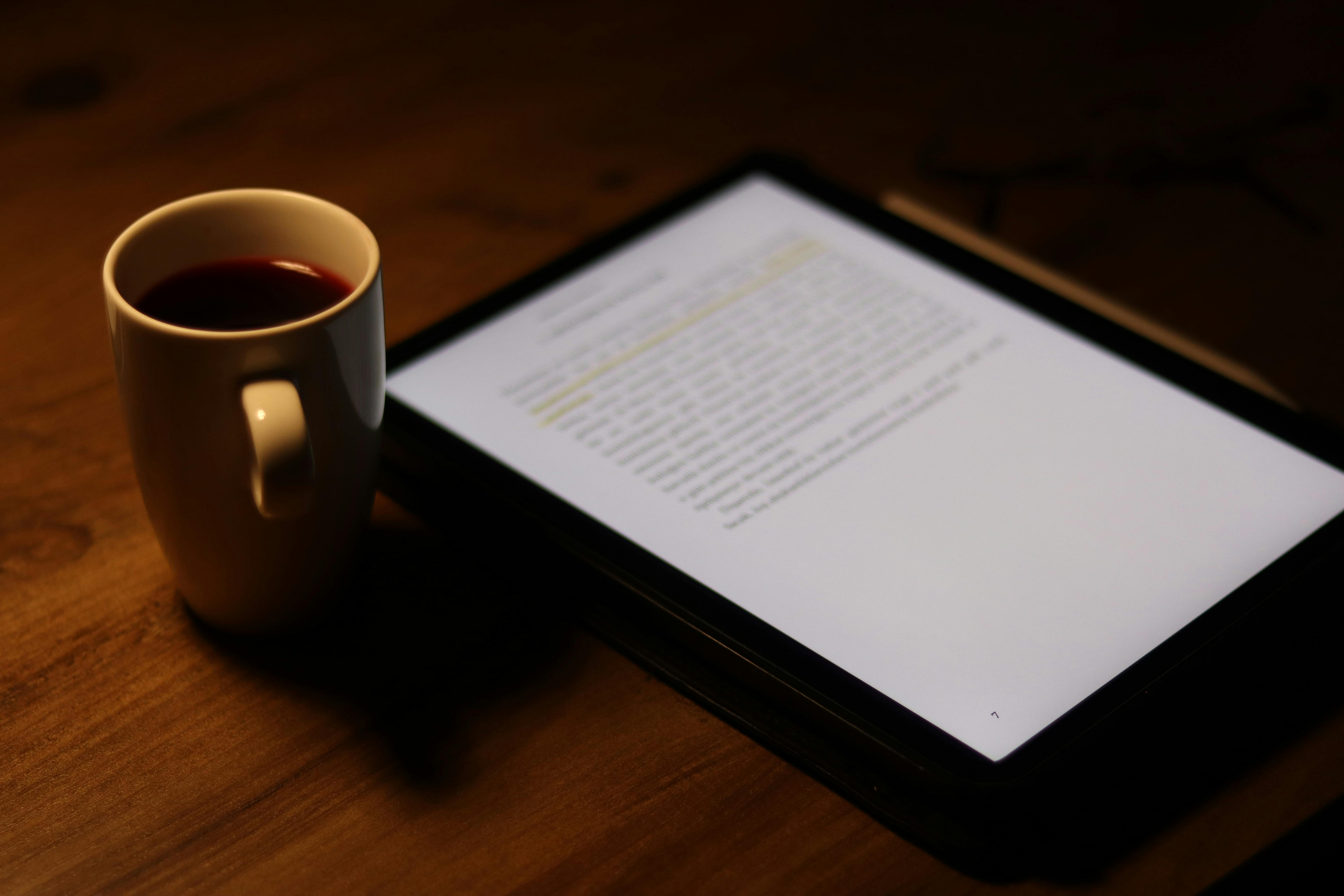 Digital Reading on Tablet with Coffee Mug · Free Stock Photo