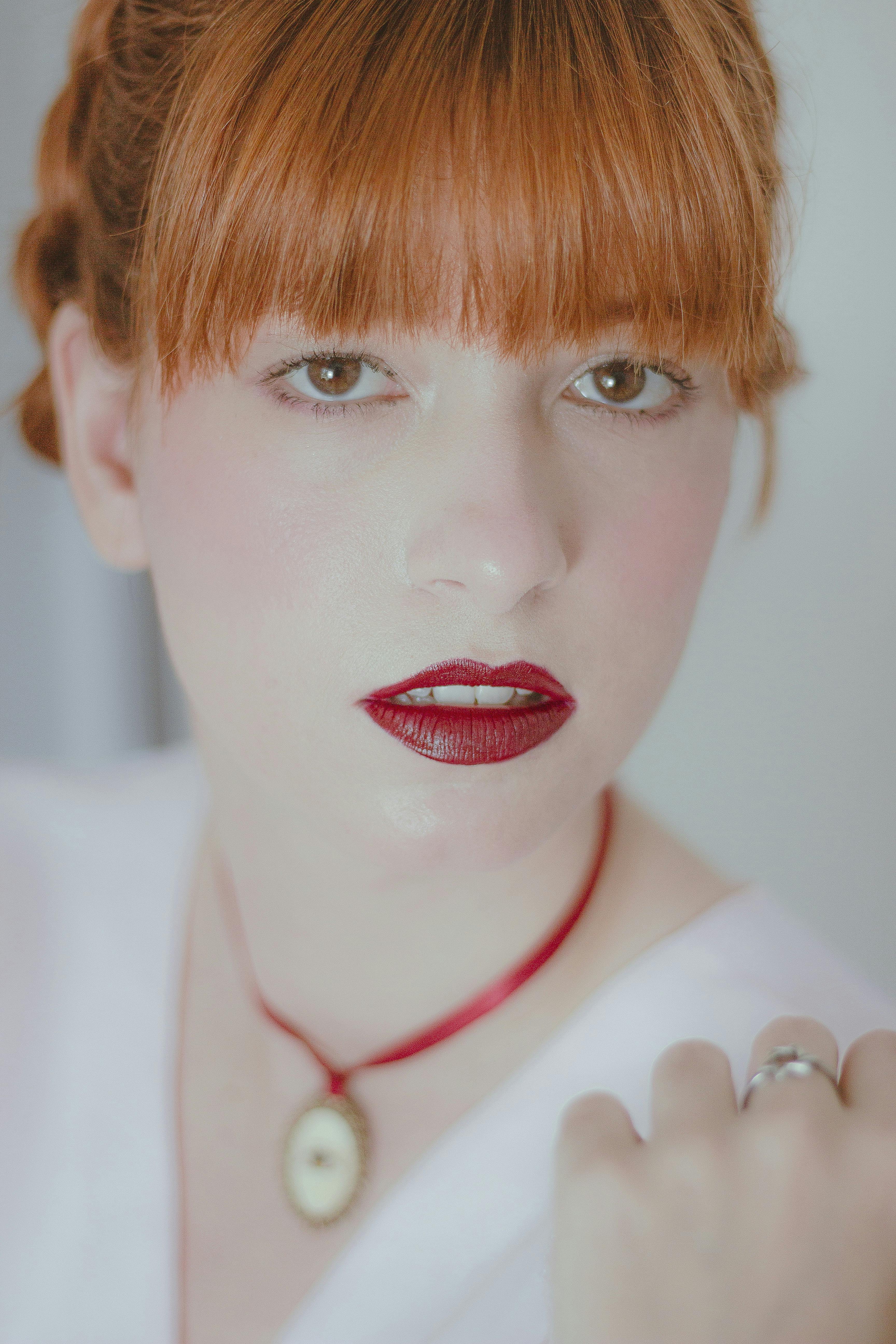 Elegant Portrait of a Redheaded Woman with Red Lips · Free Stock Photo