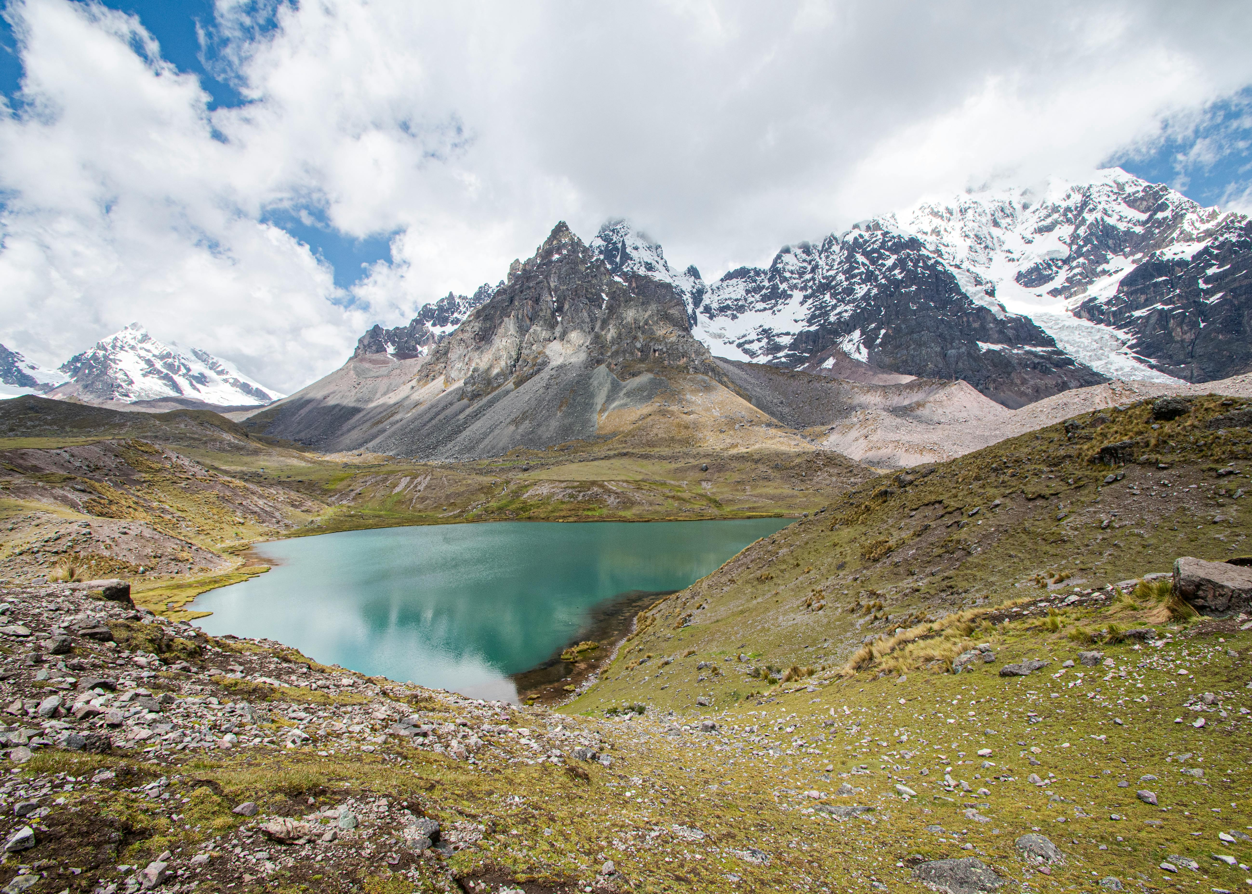 Boat floating on blue tranquil lake in verdant highlands · Free Stock Photo