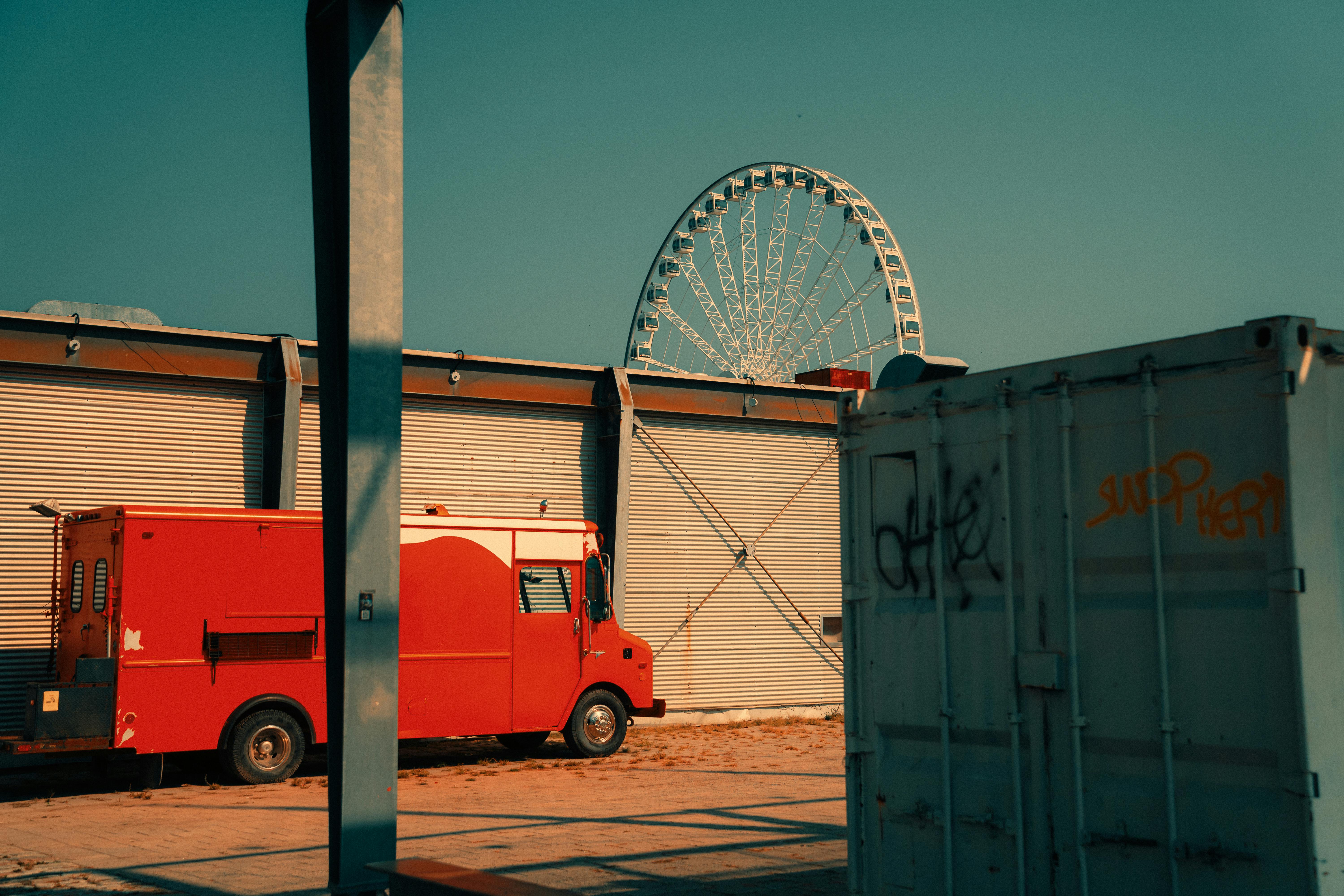 Retro Urban Scene with Ferris Wheel and Red Truck · Free Stock Photo