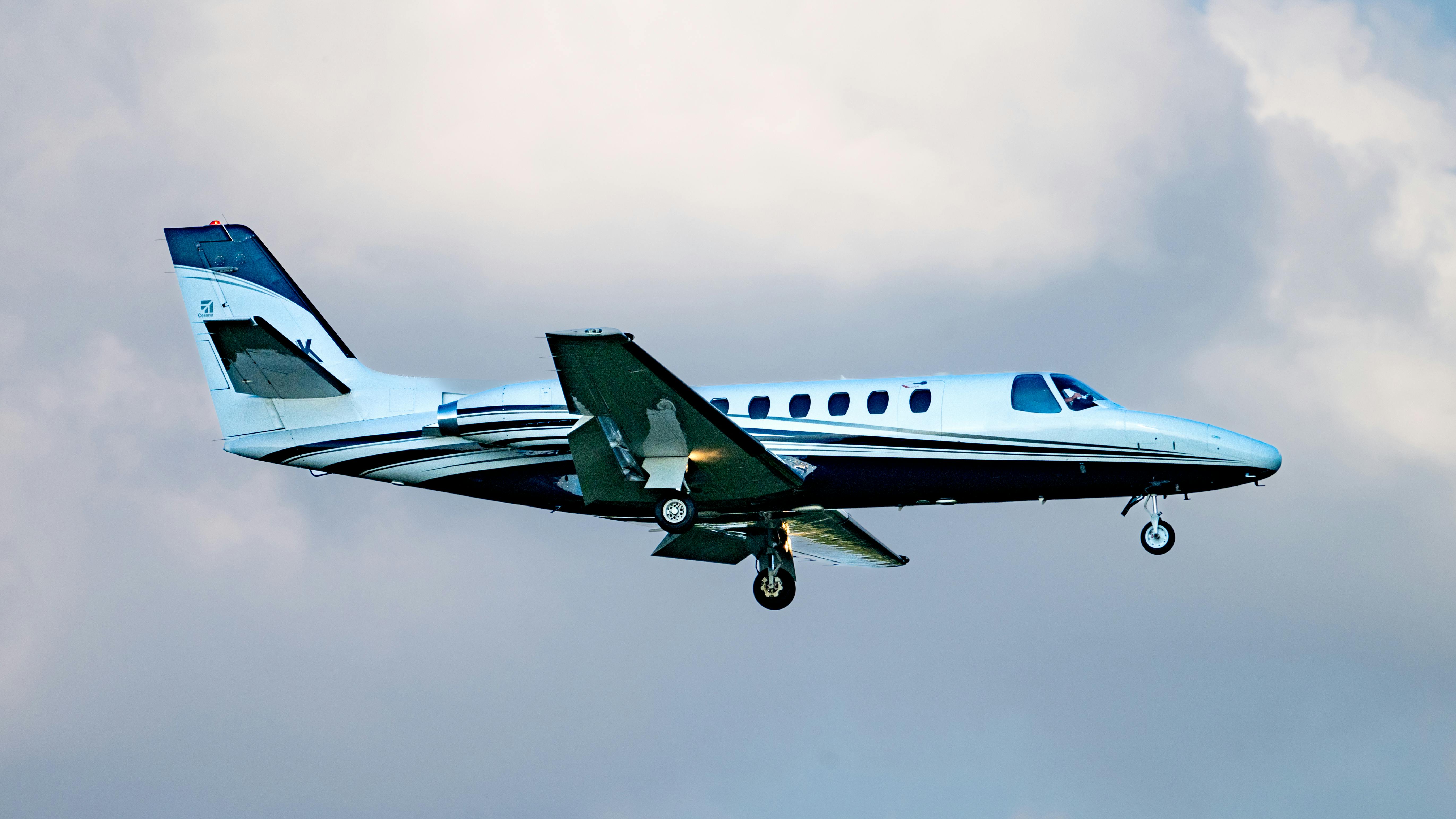 White Plane on Air Under Cloudy Sky · Free Stock Photo