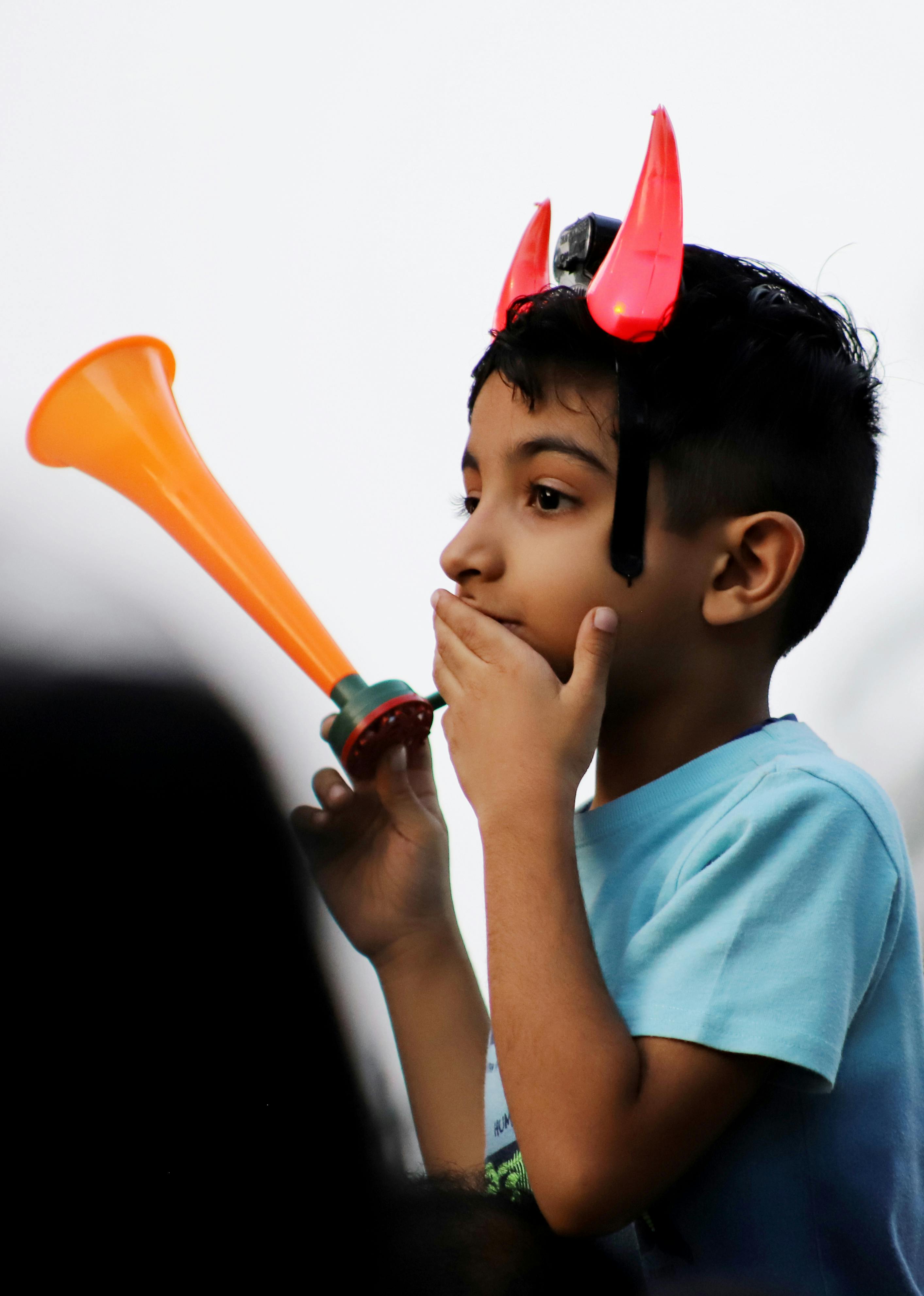 Child Celebrating with Toy Horn and Costume Horns · Free Stock Photo