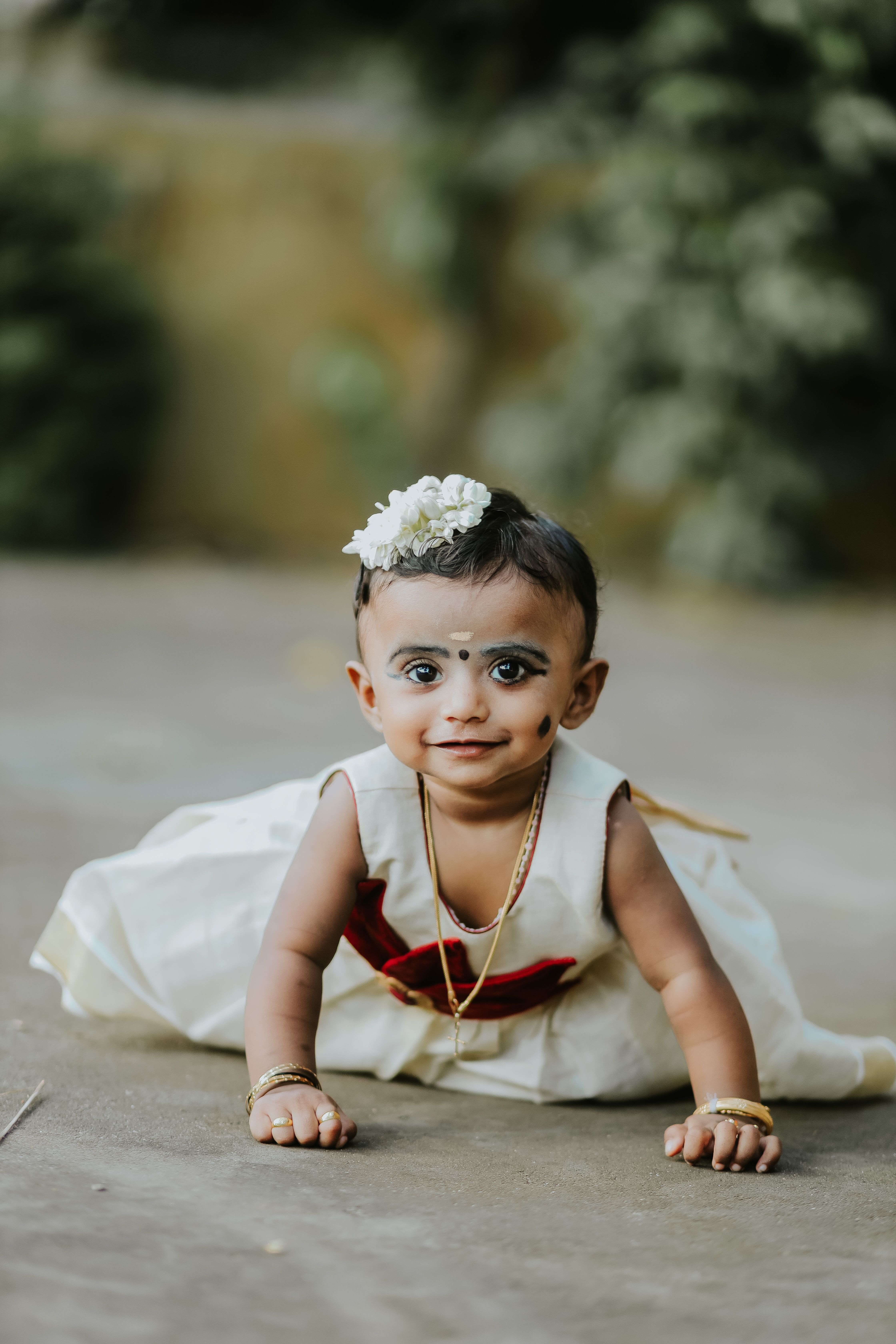 Adorable Baby in Traditional Dress Smiling · Free Stock Photo