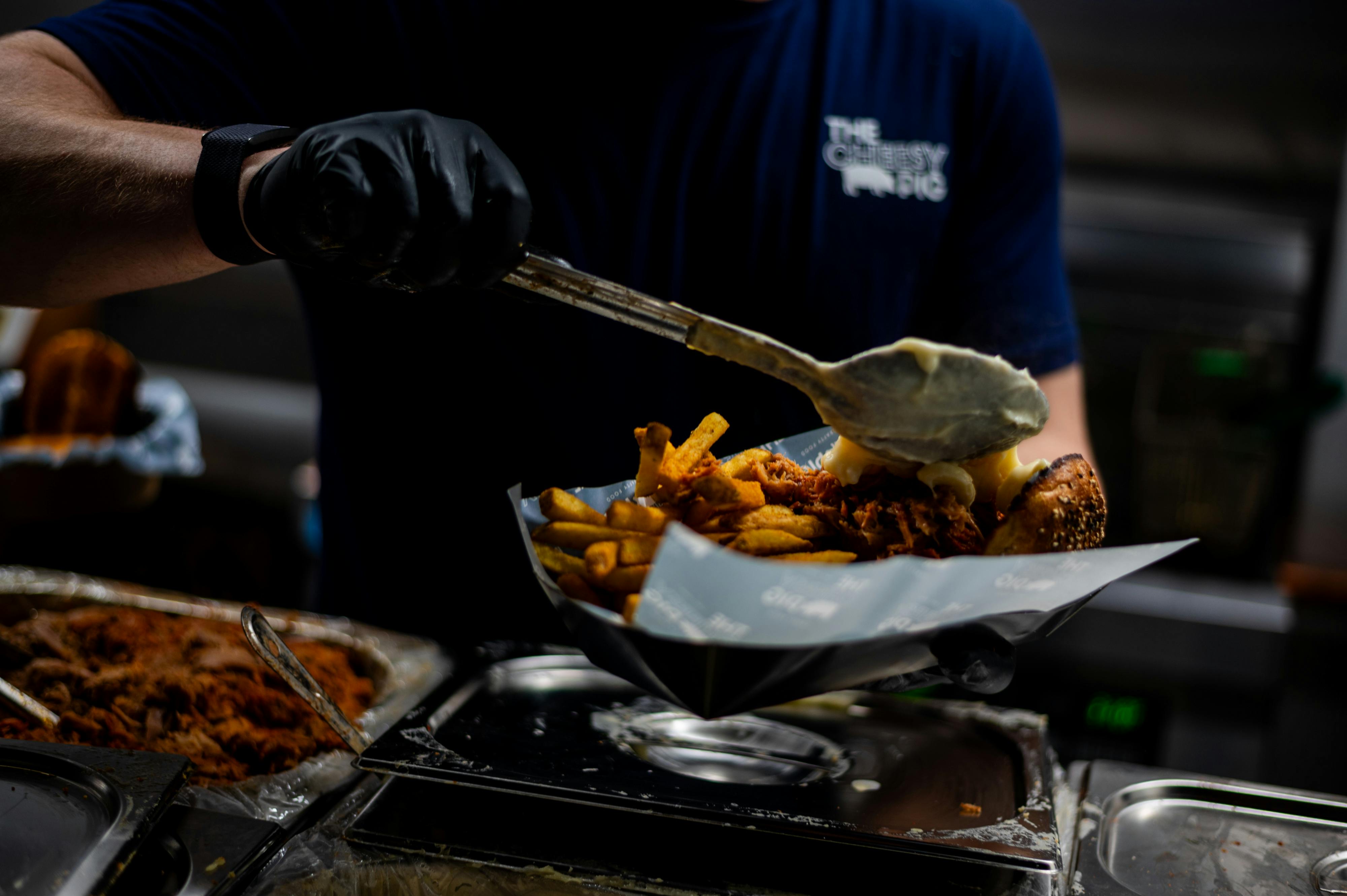 Chef Preparing Loaded Fries at Food Stall · Free Stock Photo