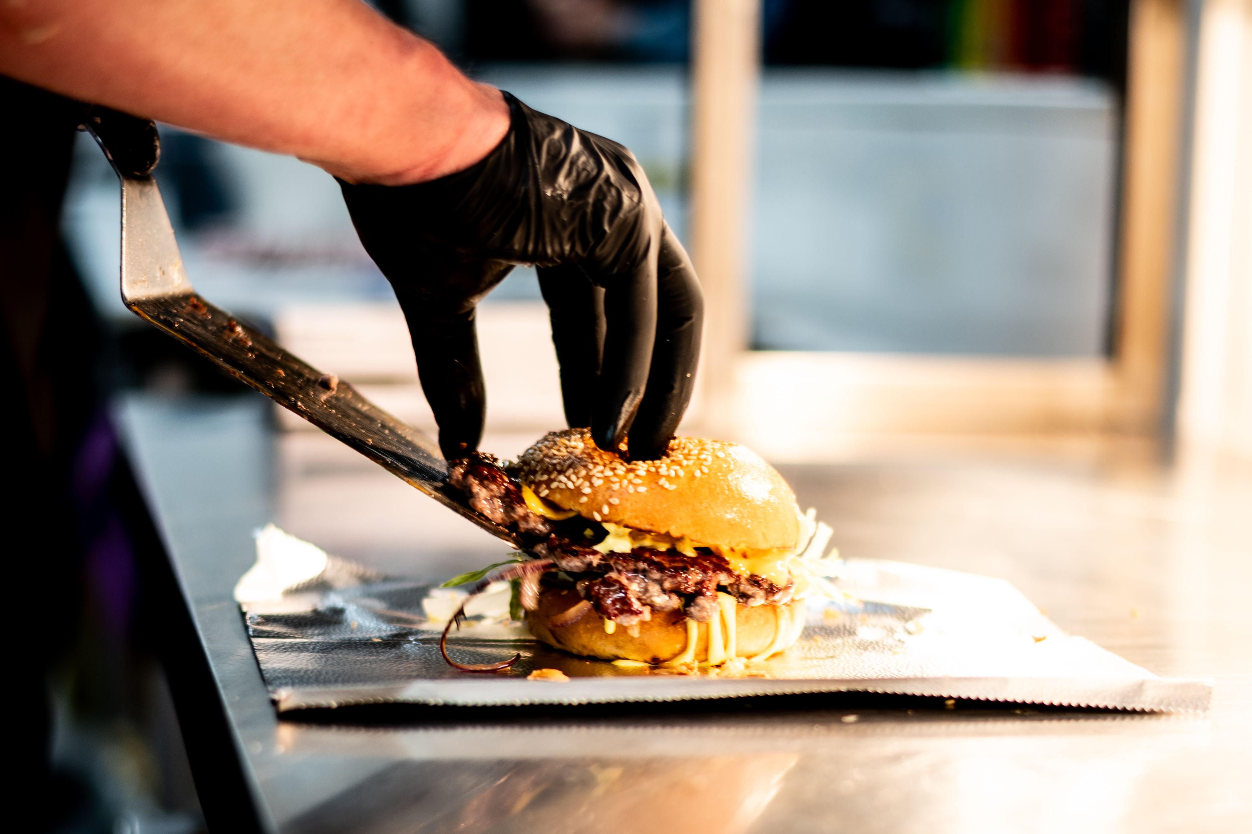 Chef Preparing Gourmet Burger in Kitchen · Free Stock Photo