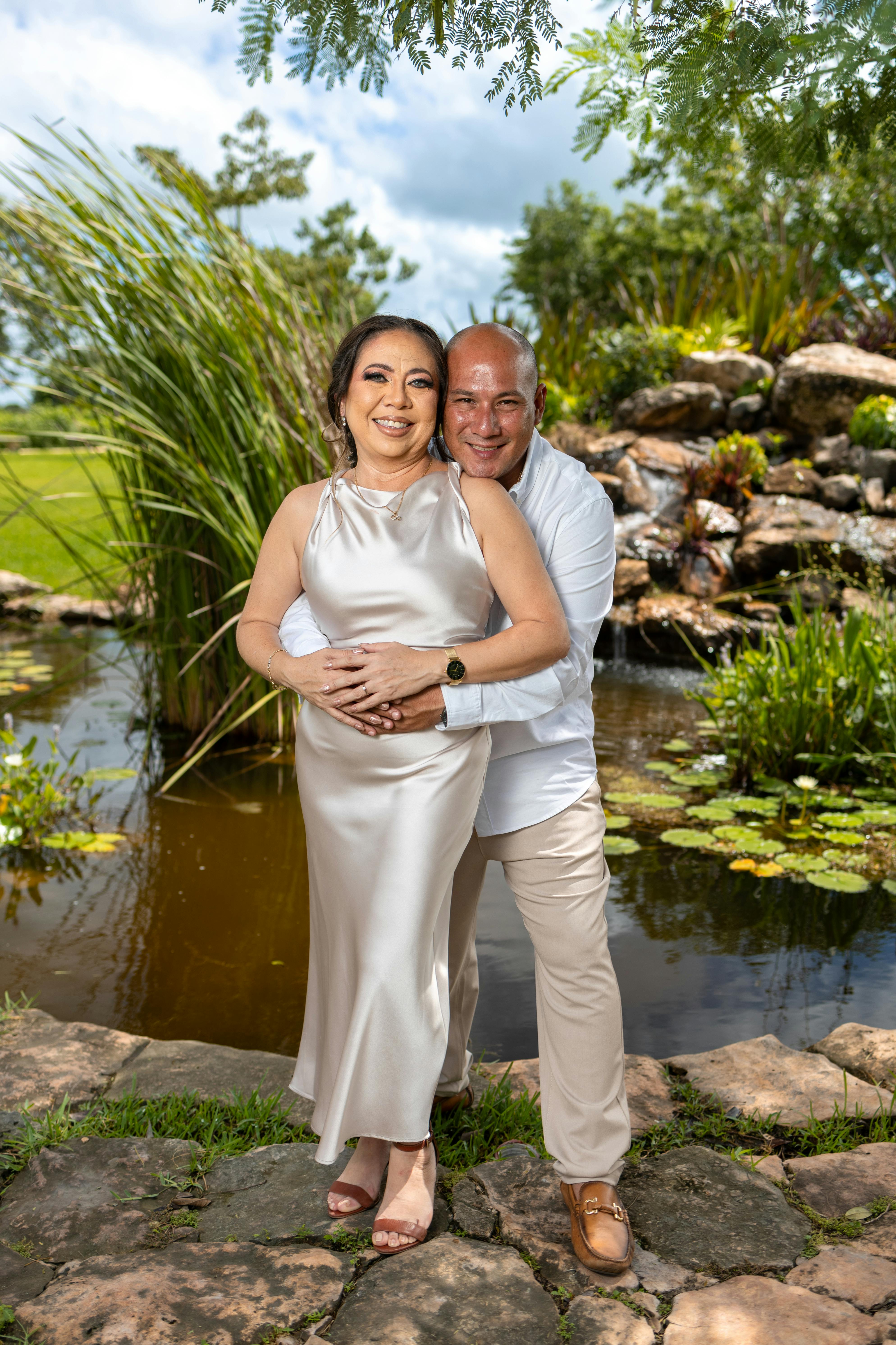 Happy Couple Embracing by a Pond in Mérida · Free Stock Photo