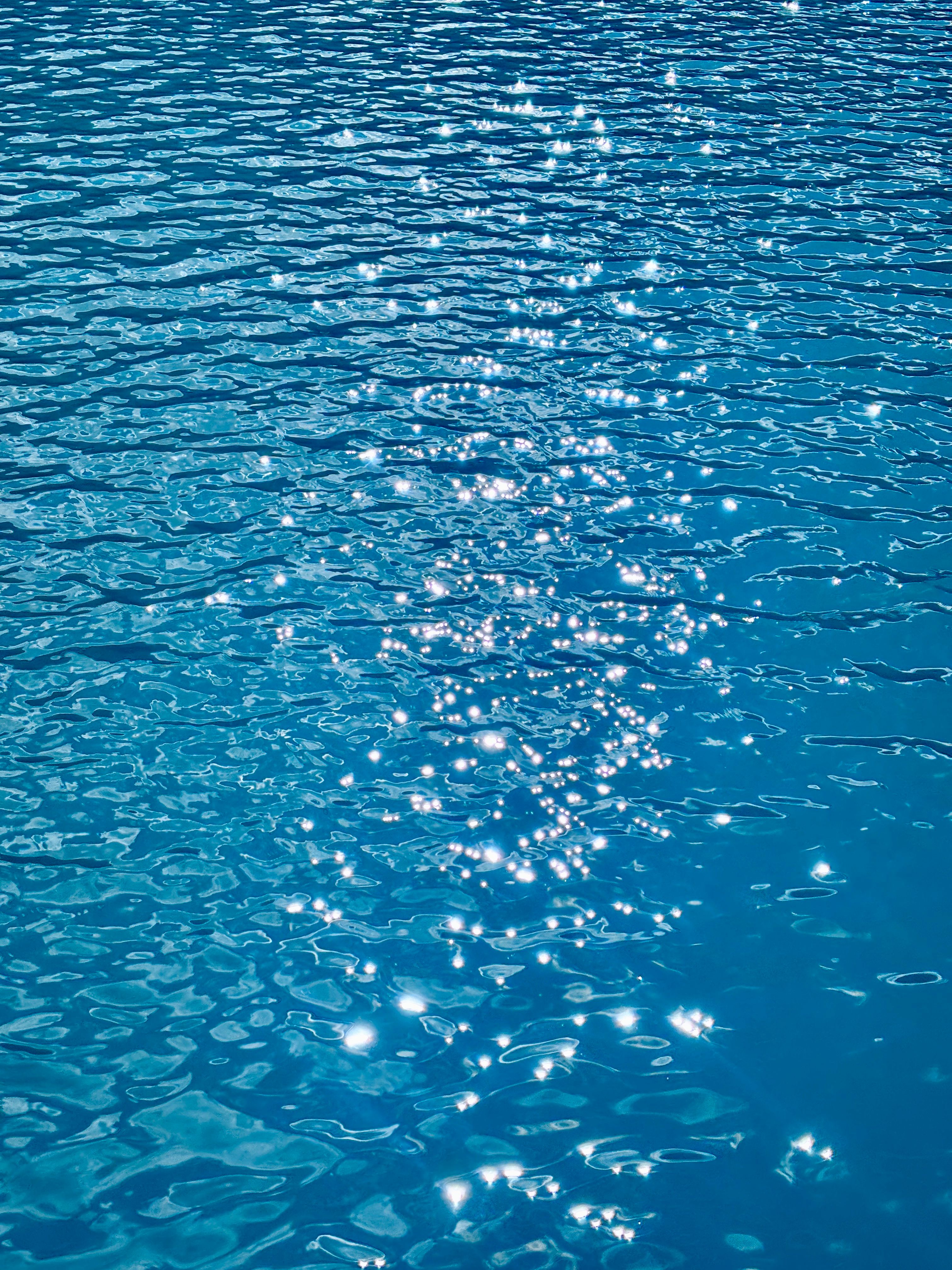 Sparkling Blue Water Surface Under Daylight · Free Stock Photo