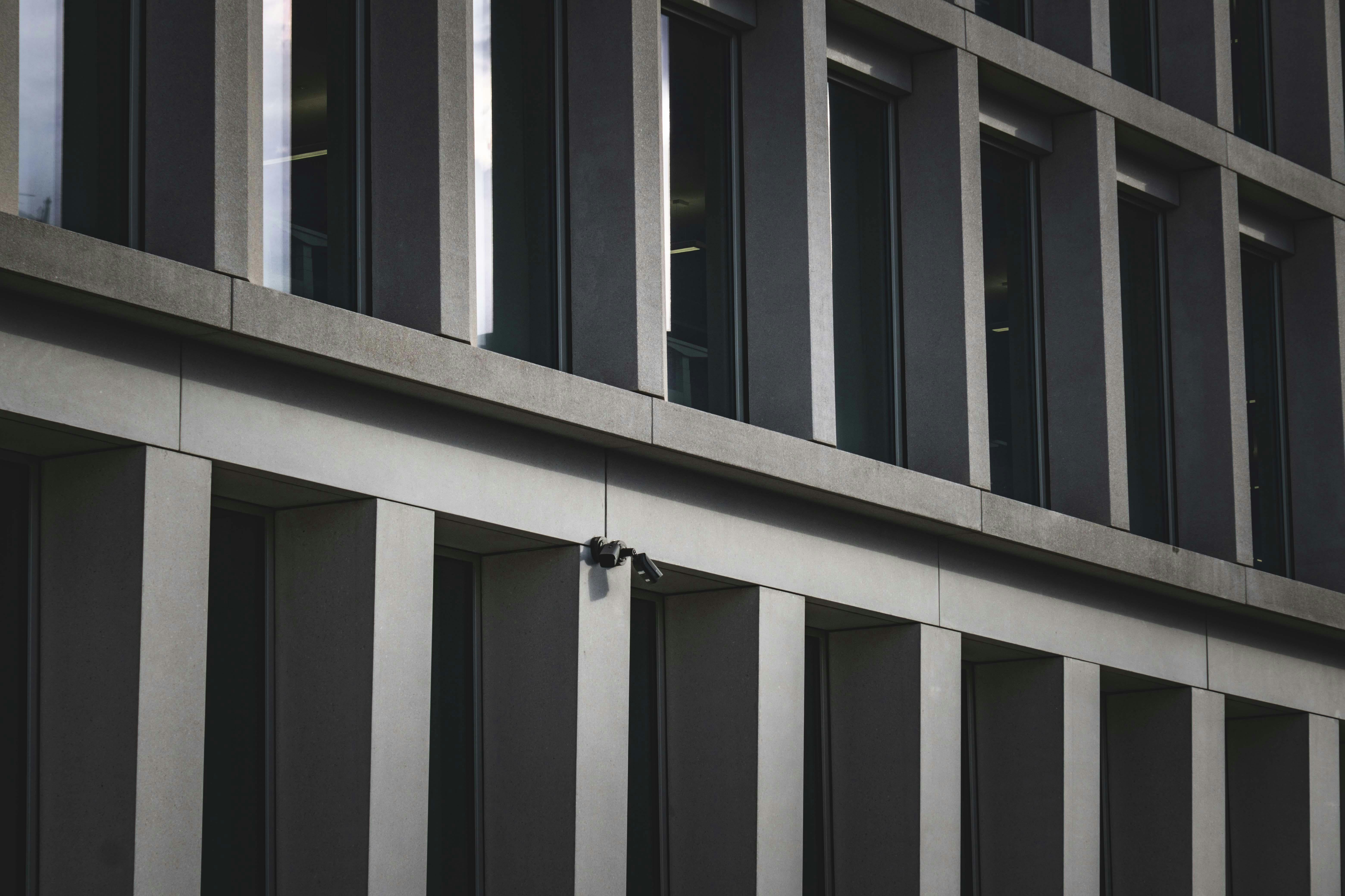 Modern Office Building Facade with Security Cameras · Free Stock Photo