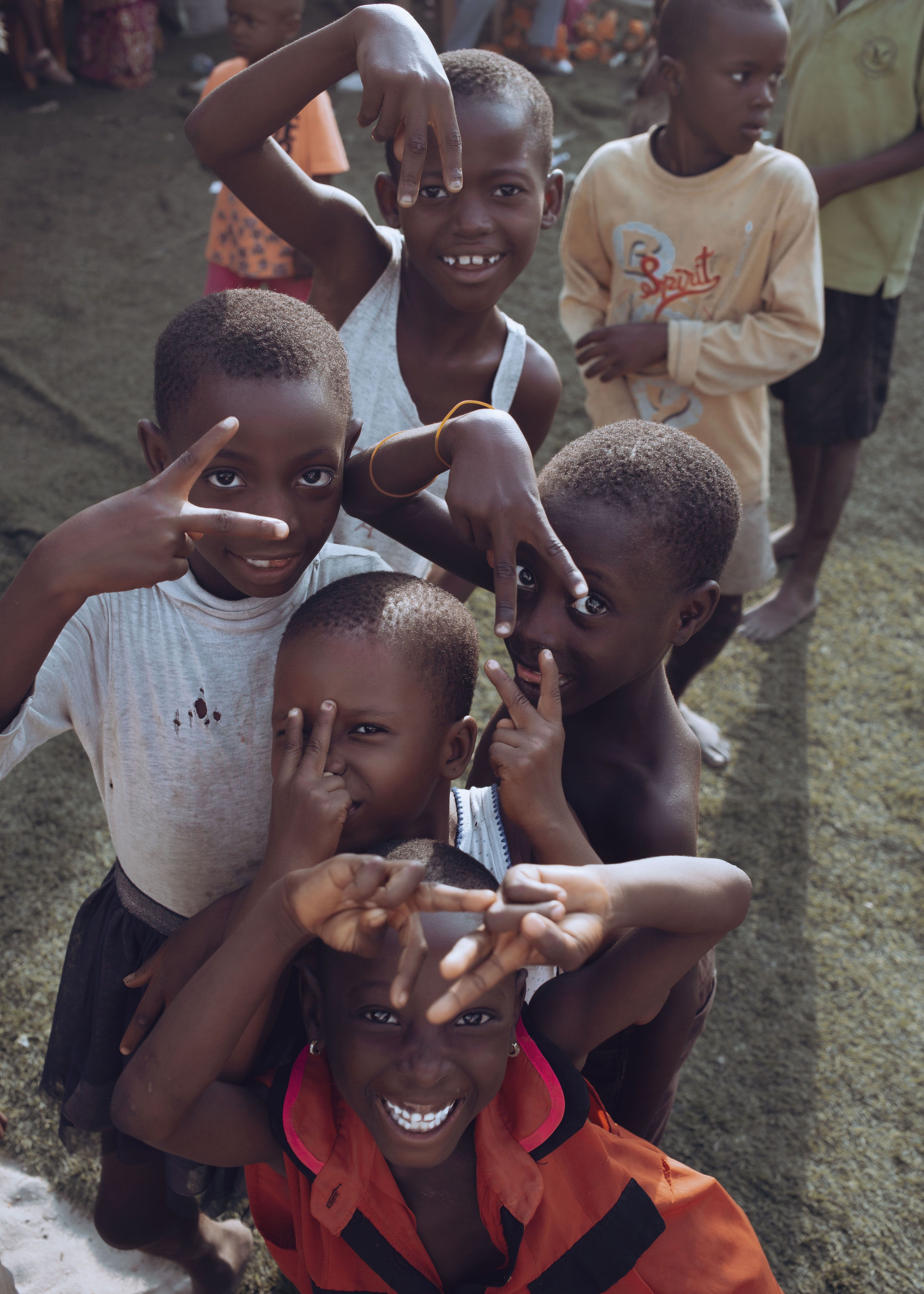 Joyful Group of Children Making Peace Signs Outdoors · Free Stock Photo