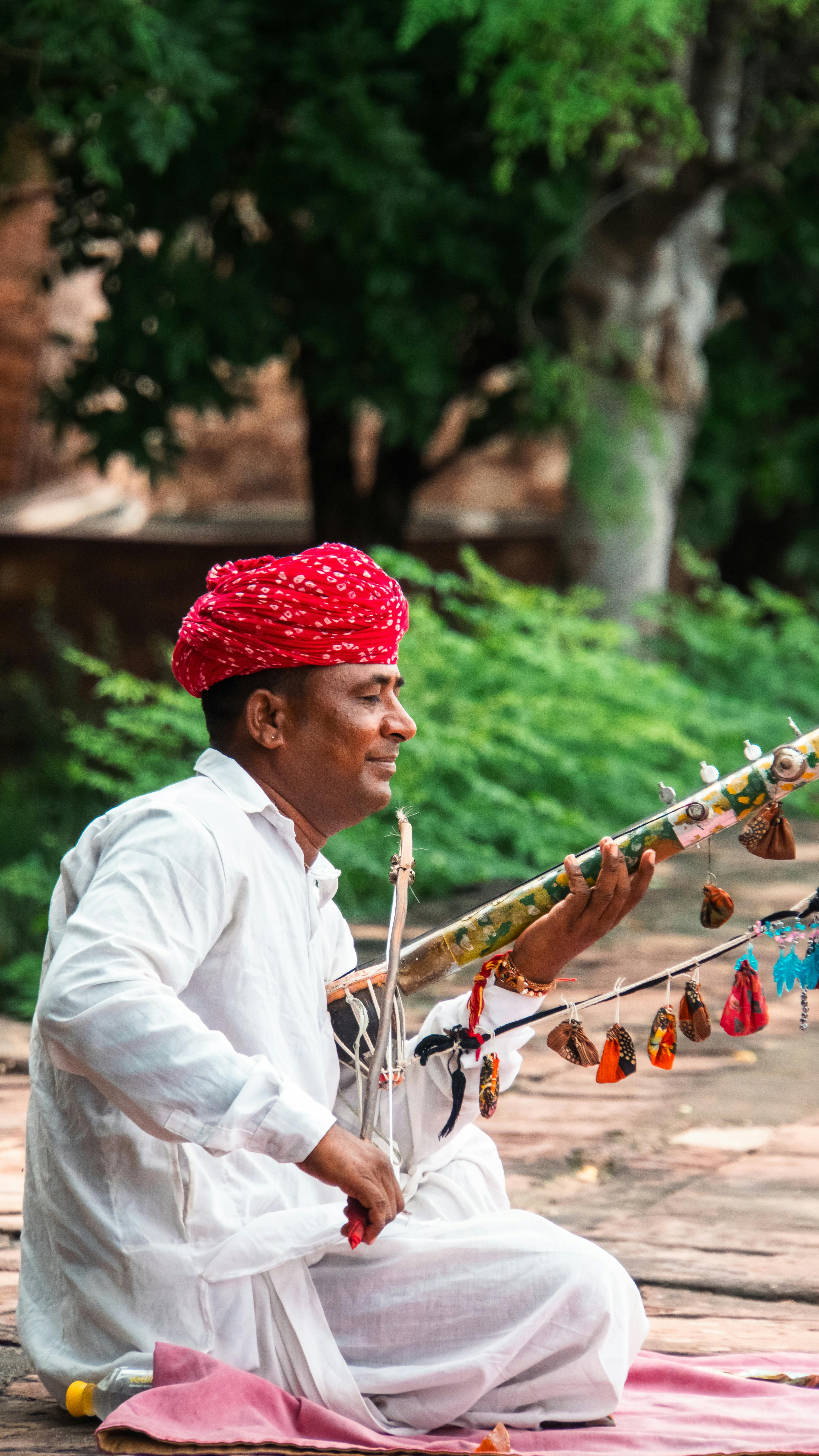 Traditional Indian Musician Playing Outdoors · Free Stock Photo