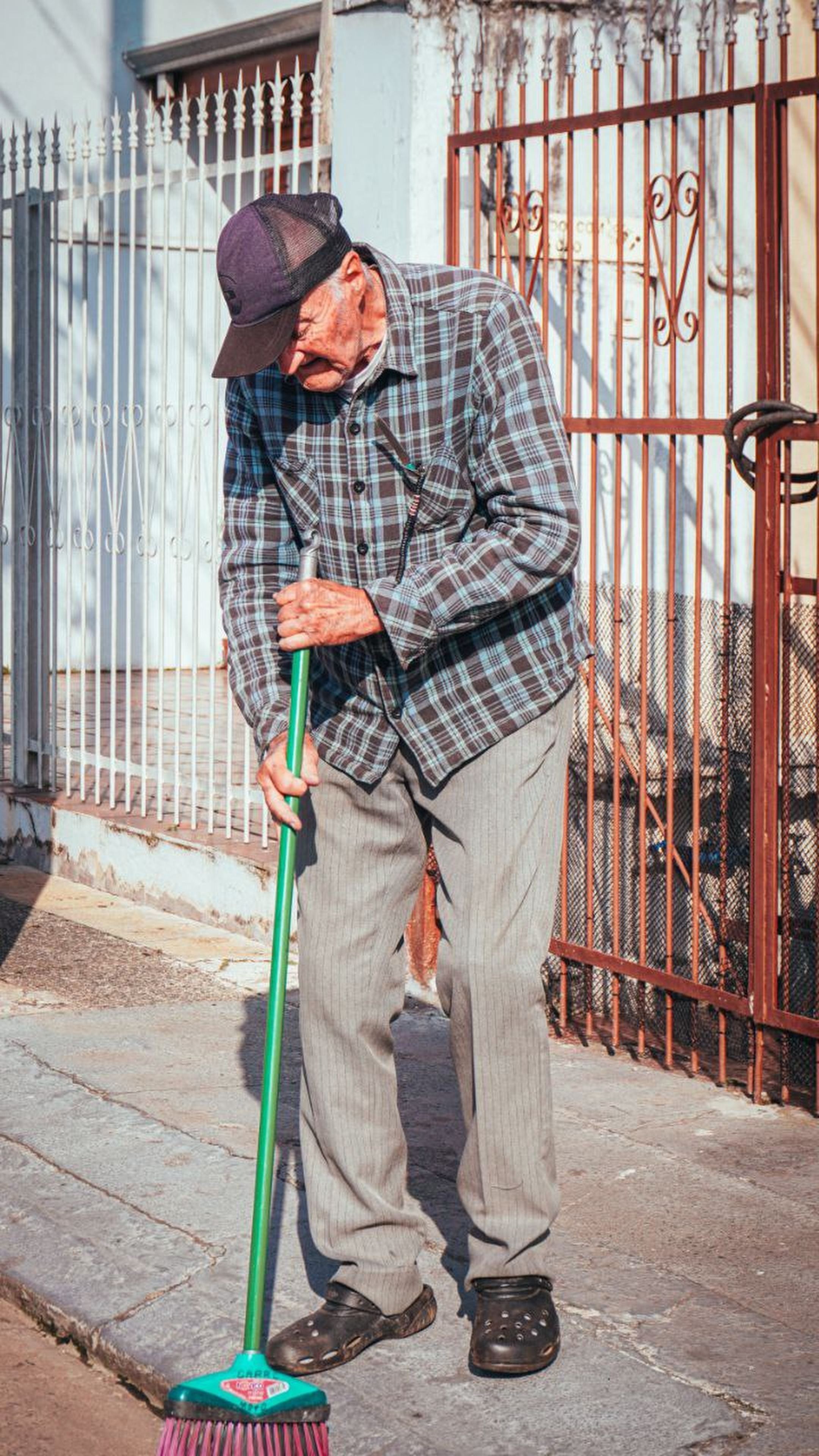Elderly Man Sweeping Sidewalk in Jundiaí, Brazil · Free Stock Photo