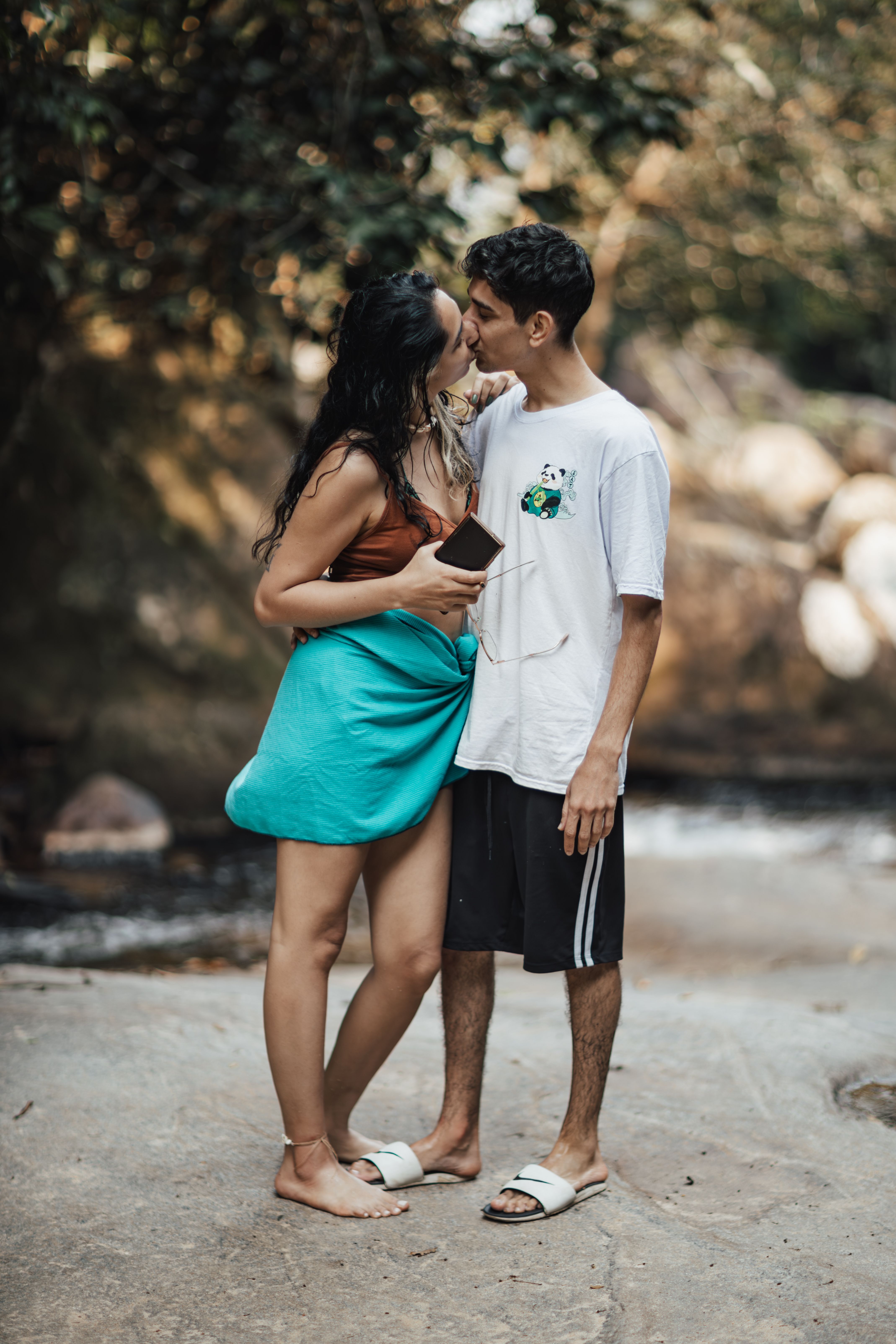 Romantic Couple Embracing by a Stream Outdoors · Free Stock Photo