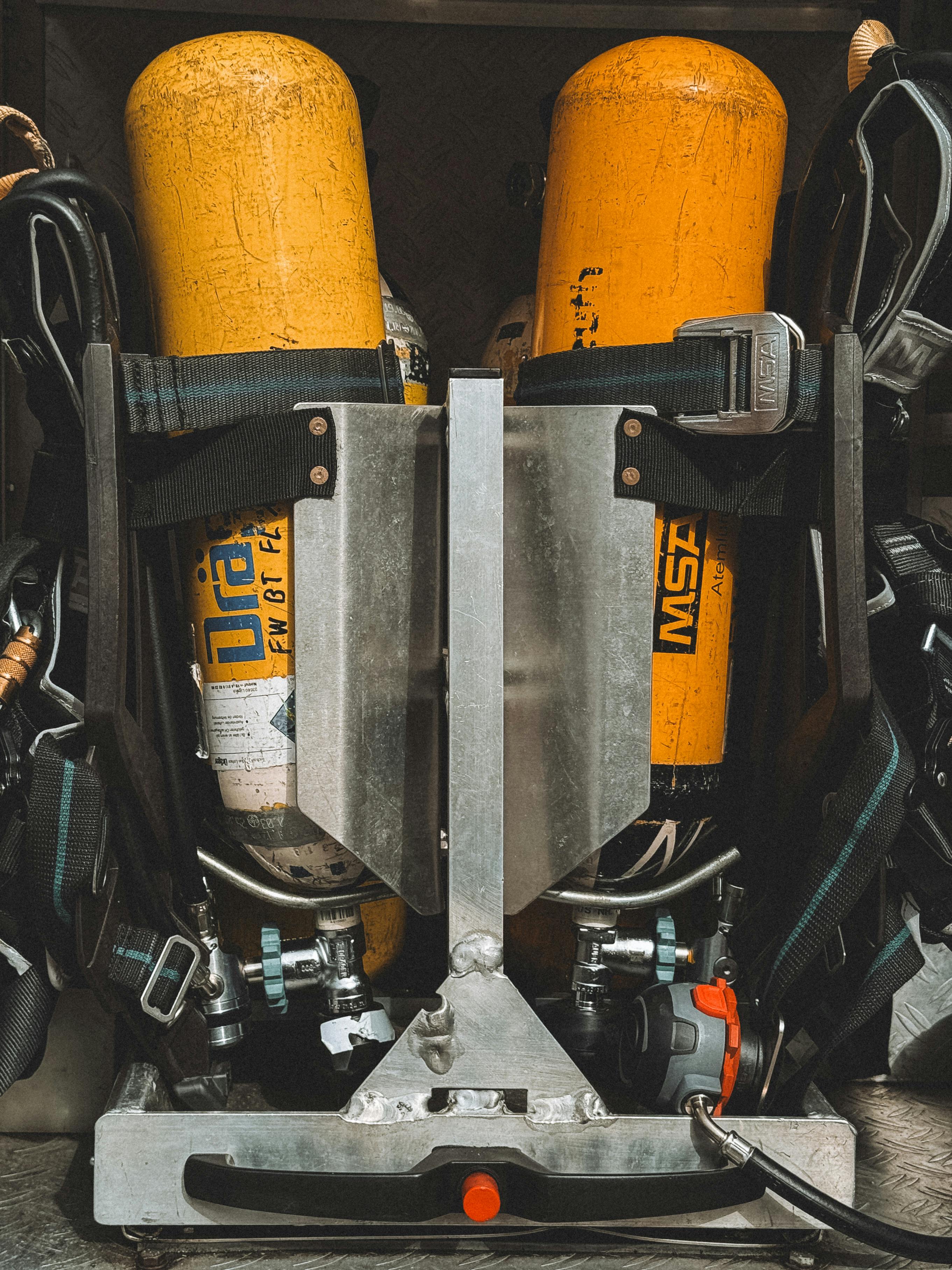 Close-up of Industrial Oxygen Tanks with Straps · Free Stock Photo