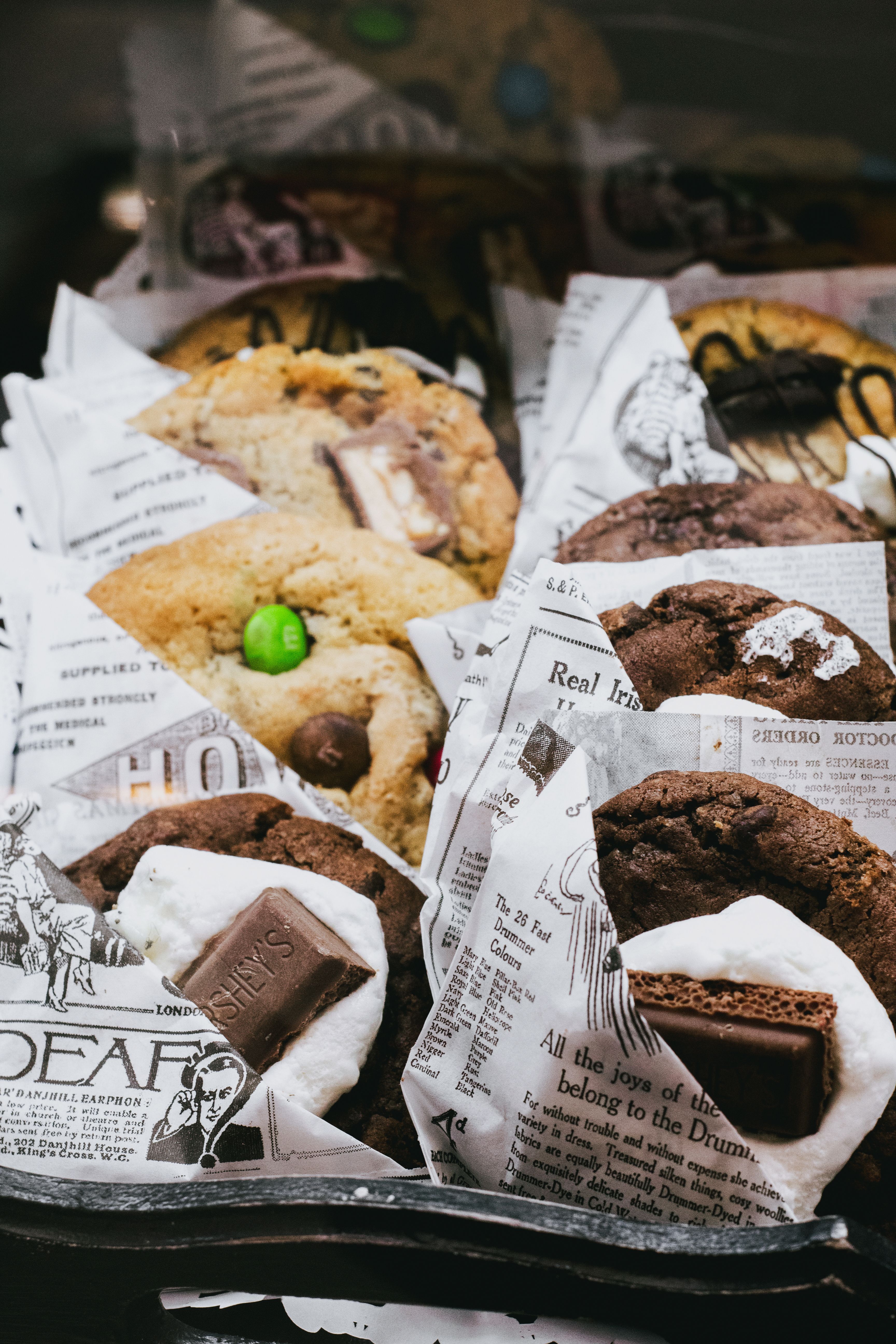 Assorted Gourmet Cookies on Newspaper Wraps · Free Stock Photo