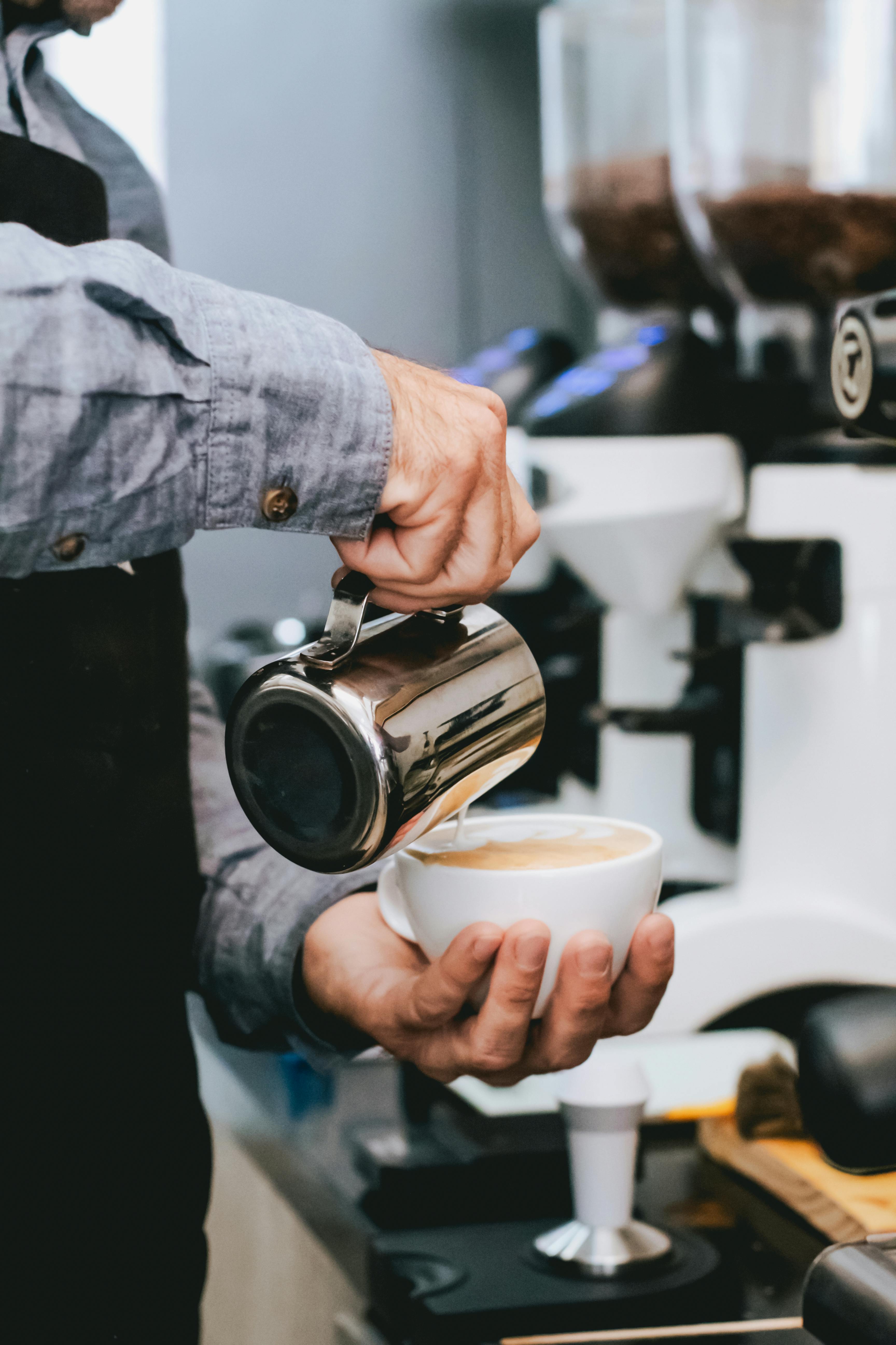 Man creating latte art with cream · Free Stock Photo