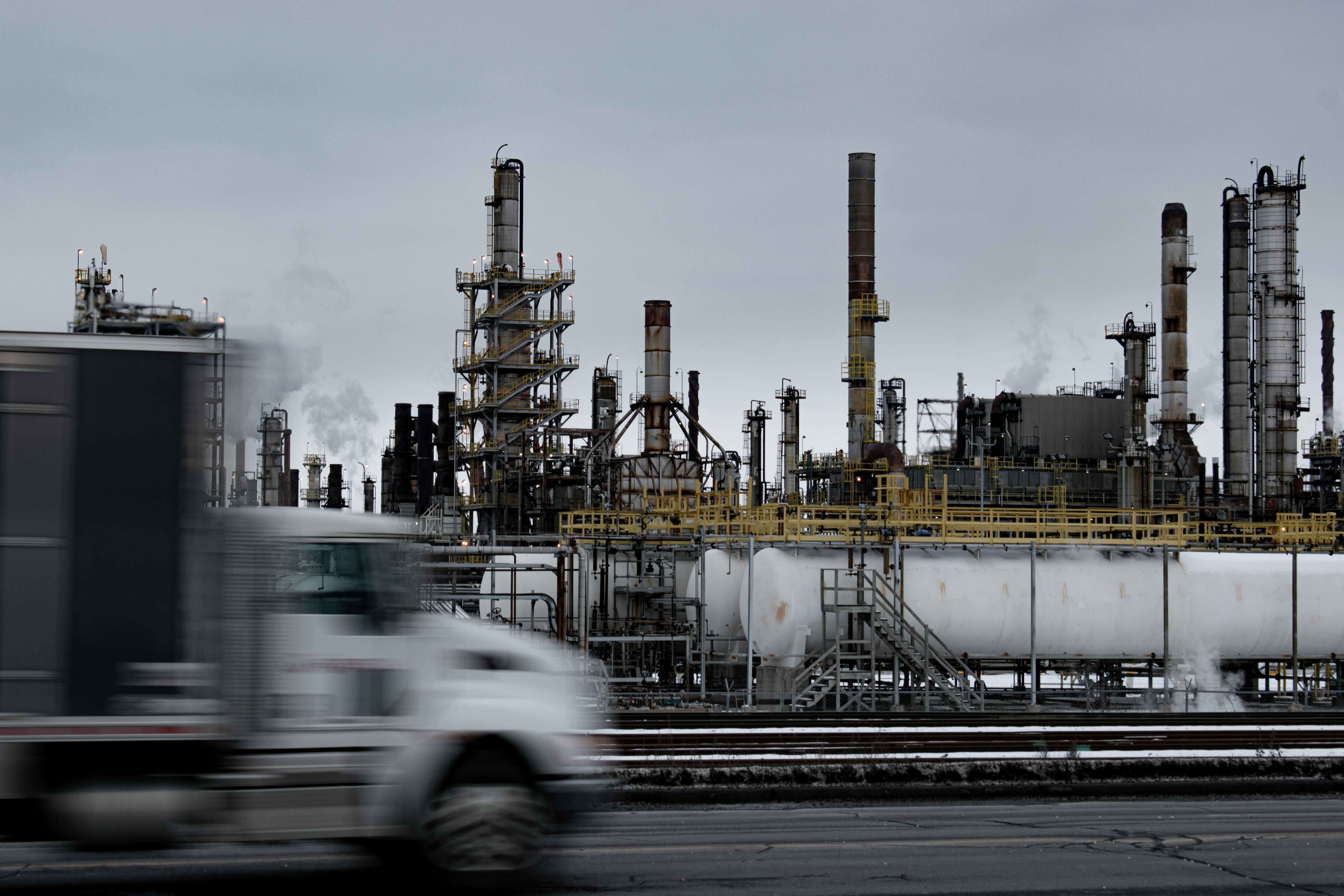 Industrial Factory with Passing Truck at Dusk · Free Stock Photo