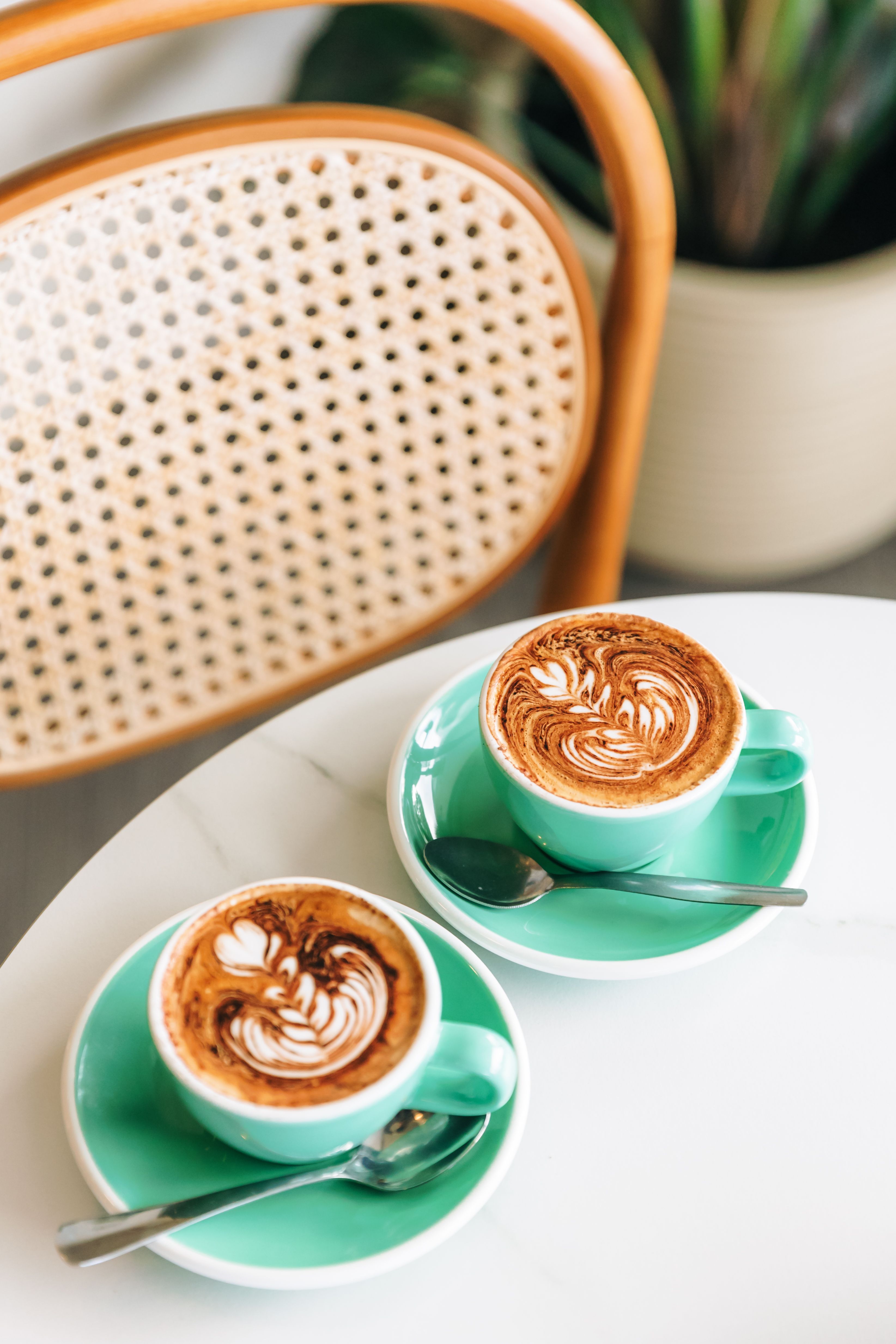 Artistic Coffee Designs in Elegant Cafe Setting · Free Stock Photo