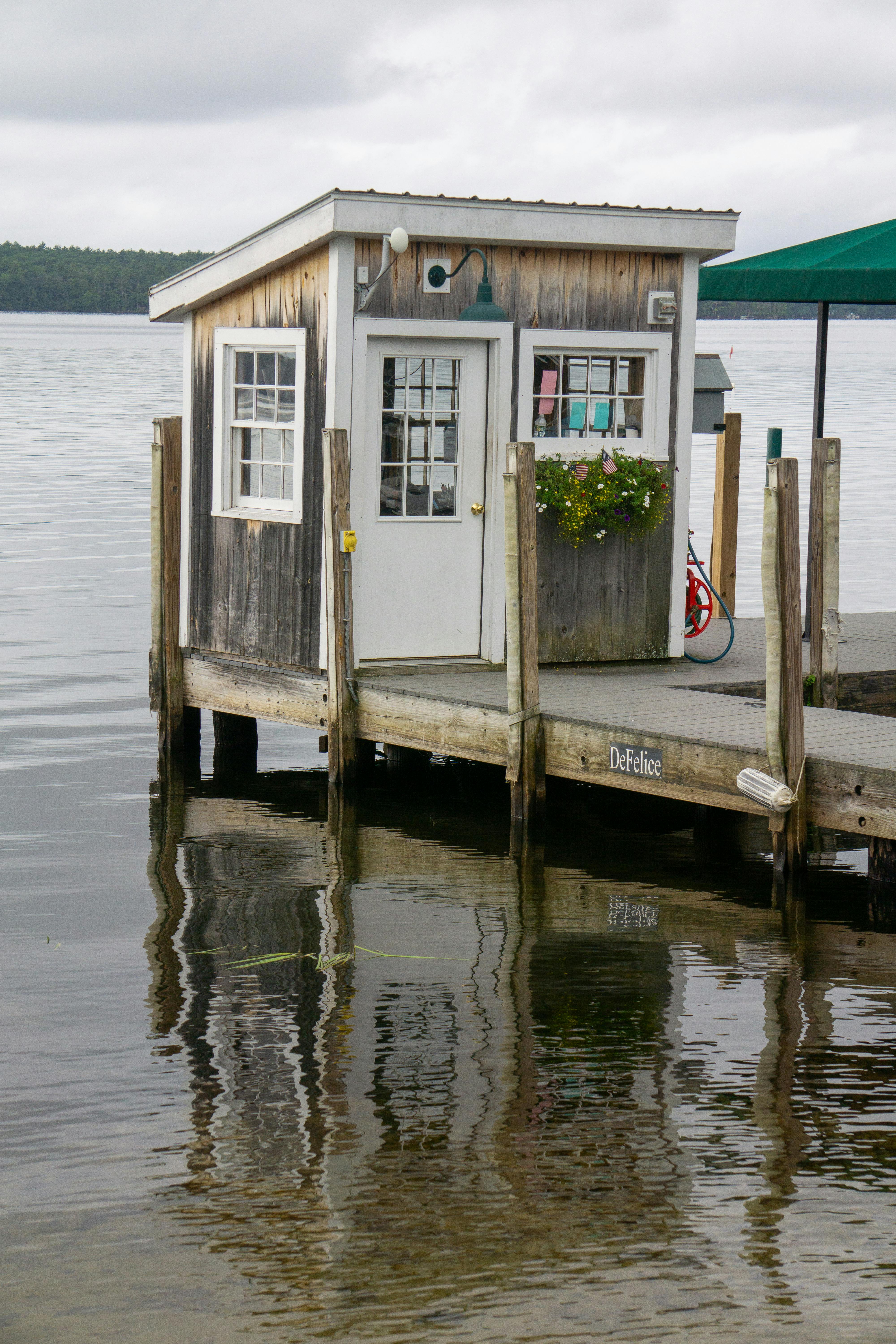 Rustic Wooden Boathouse Reflected on a Lake · Free Stock Photo