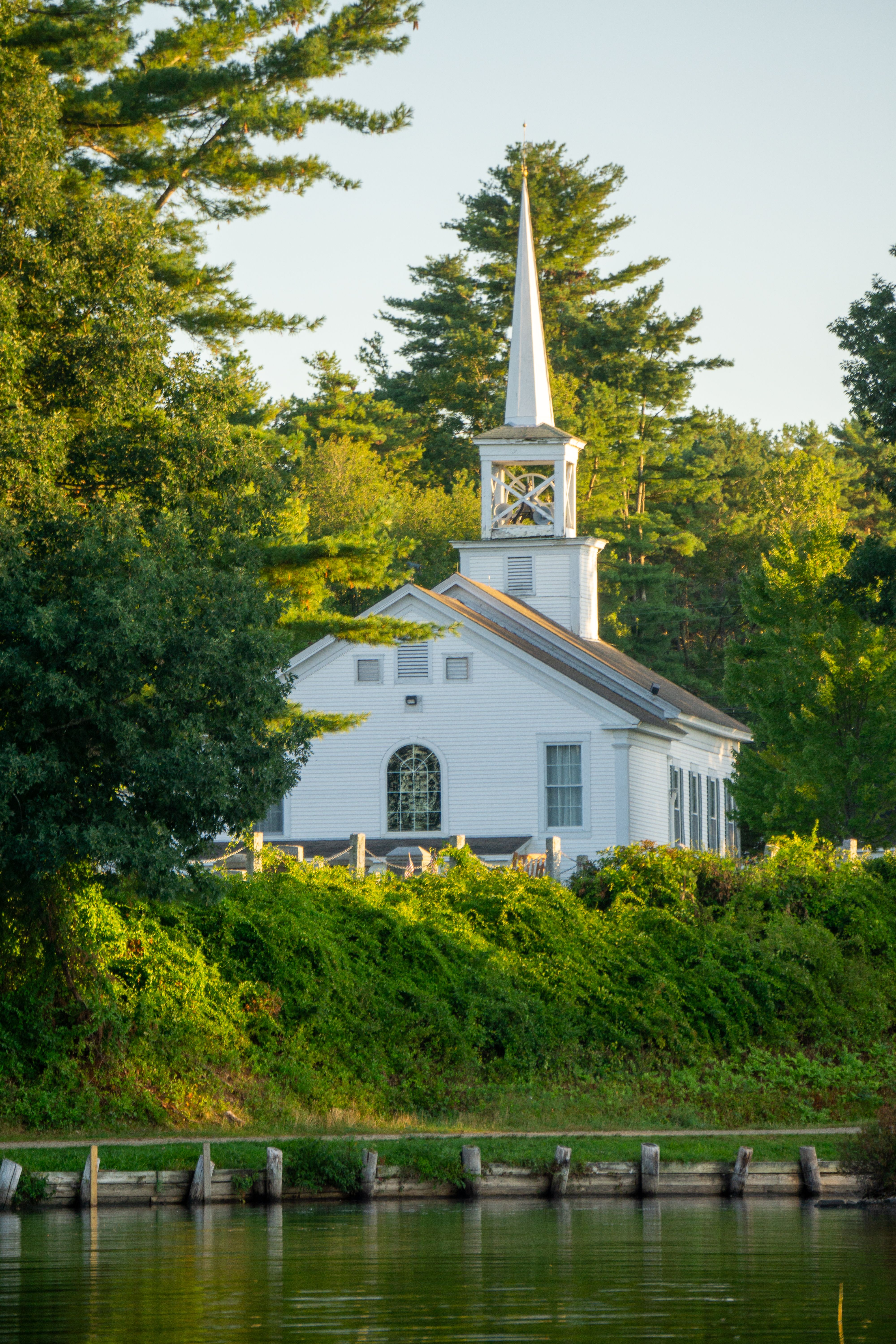 Charming White Church in Lush Forest Setting · Free Stock Photo